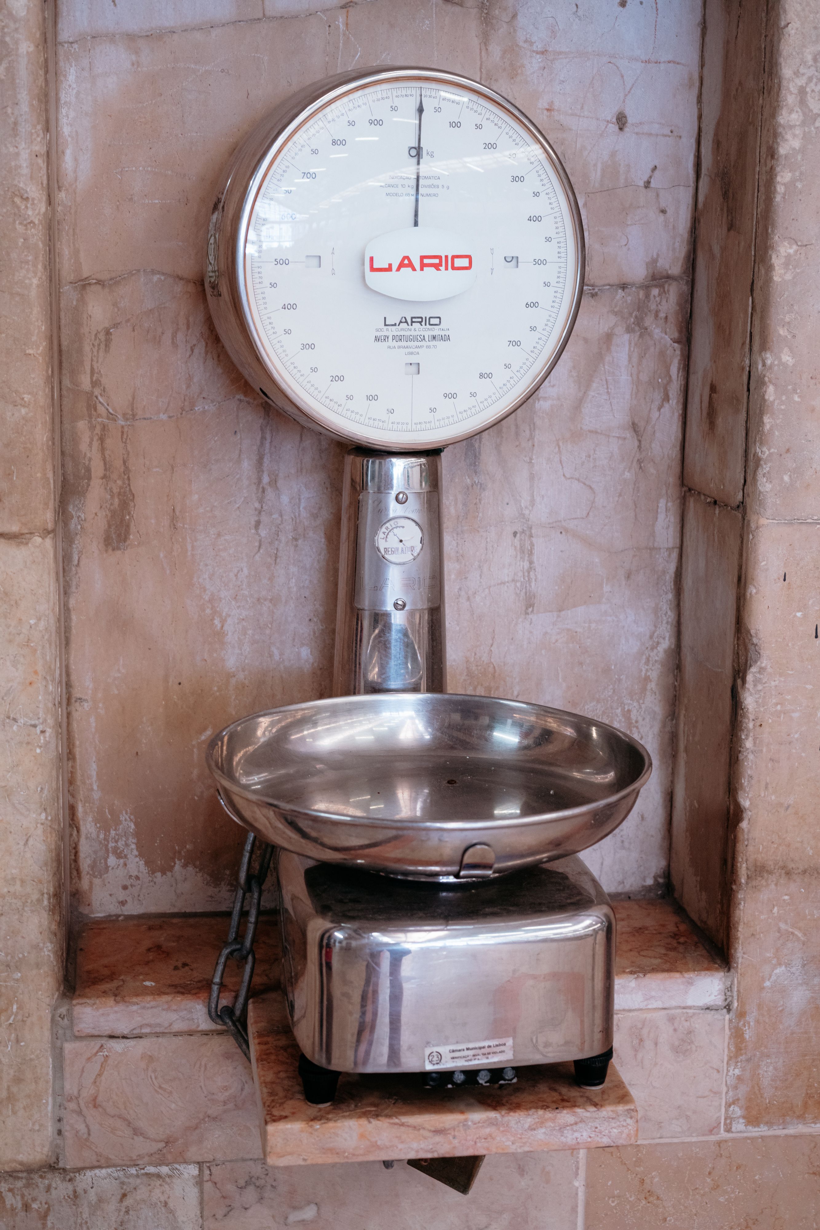 A metal scale on a wall with a bowl on top · Free Stock Photo