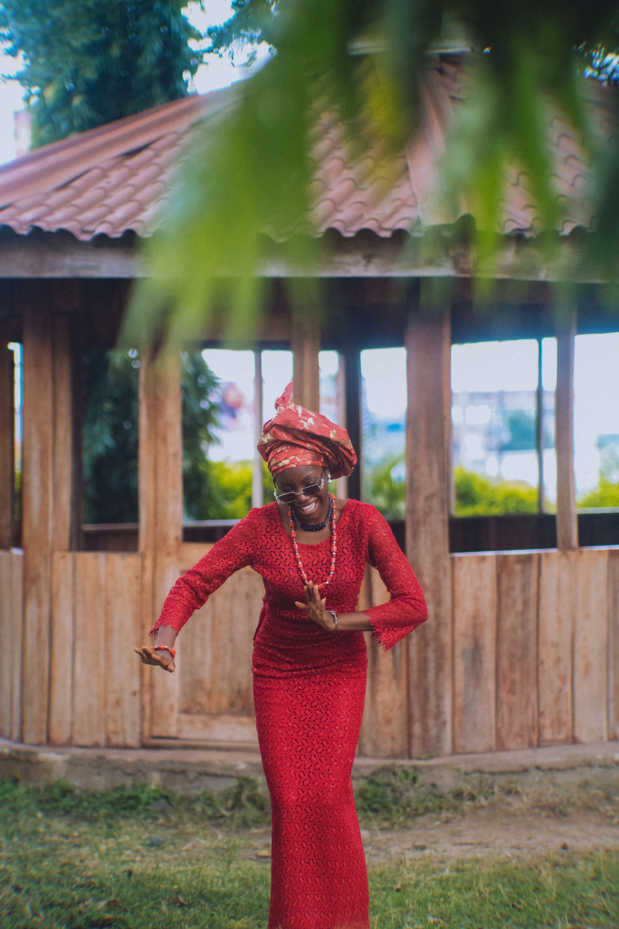 A woman in red dress dancing in front of a gazebo · Free Stock Photo