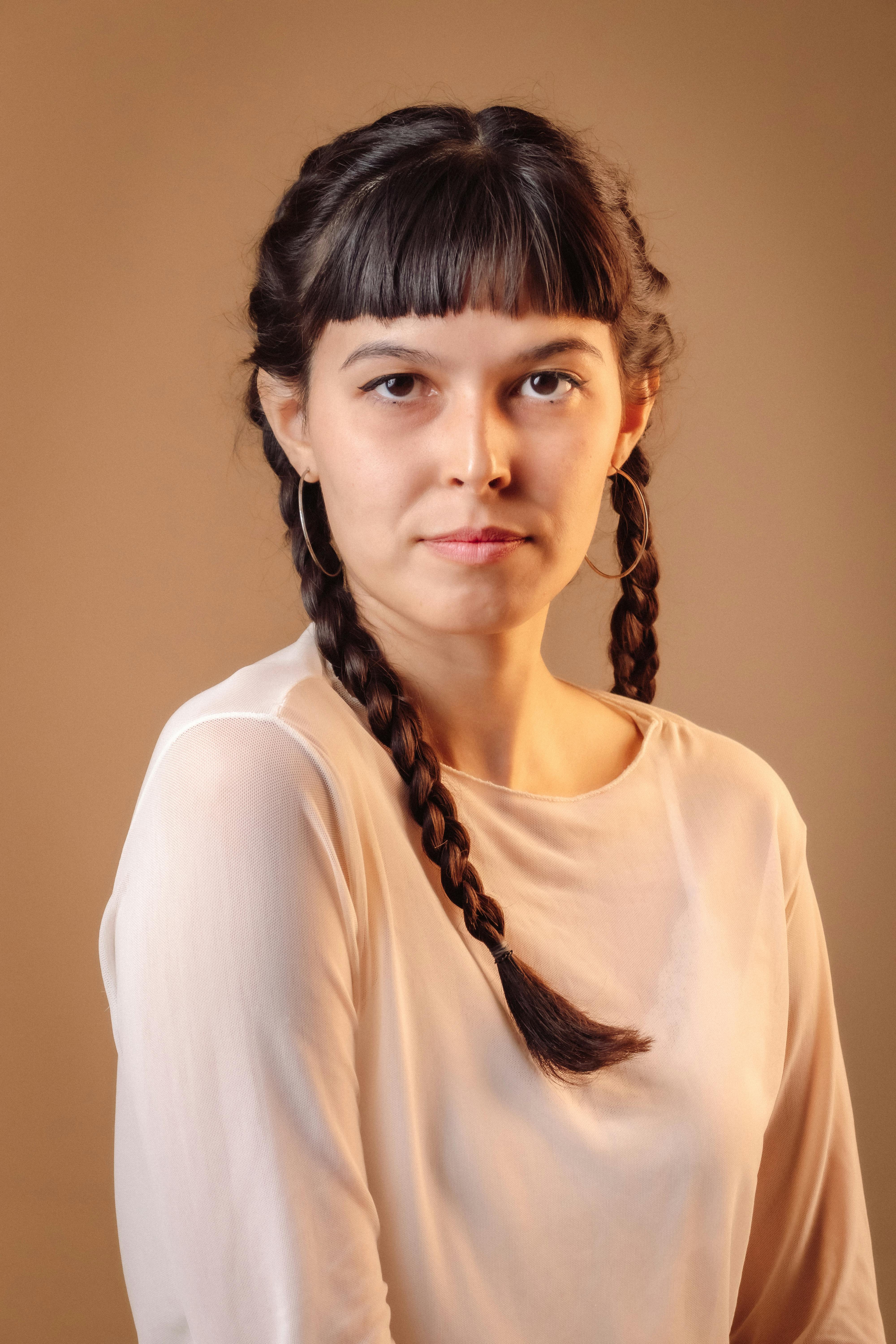 A woman with long hair and a braid on her head · Free Stock Photo