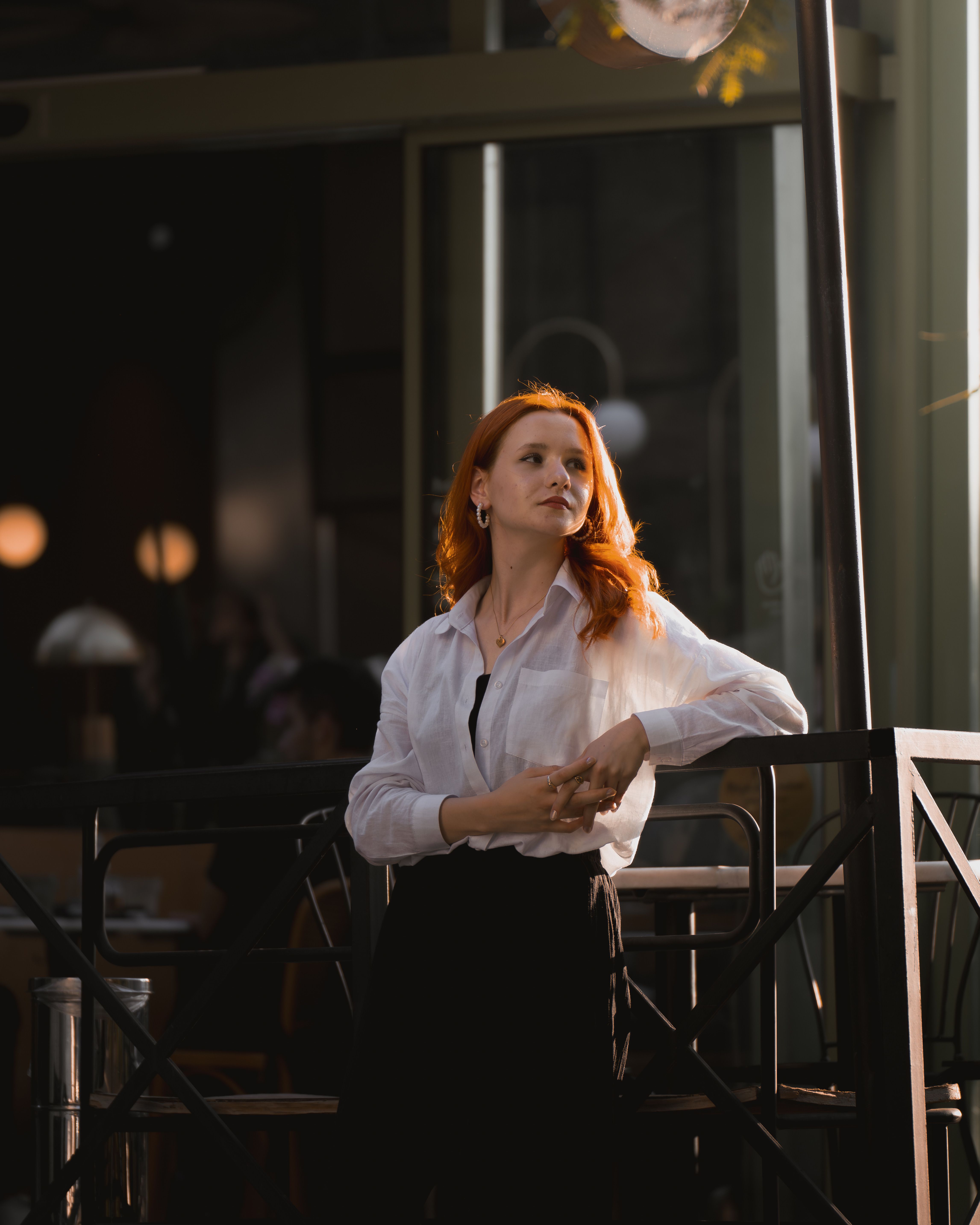 A woman with red hair and white shirt standing outside · Free Stock Photo