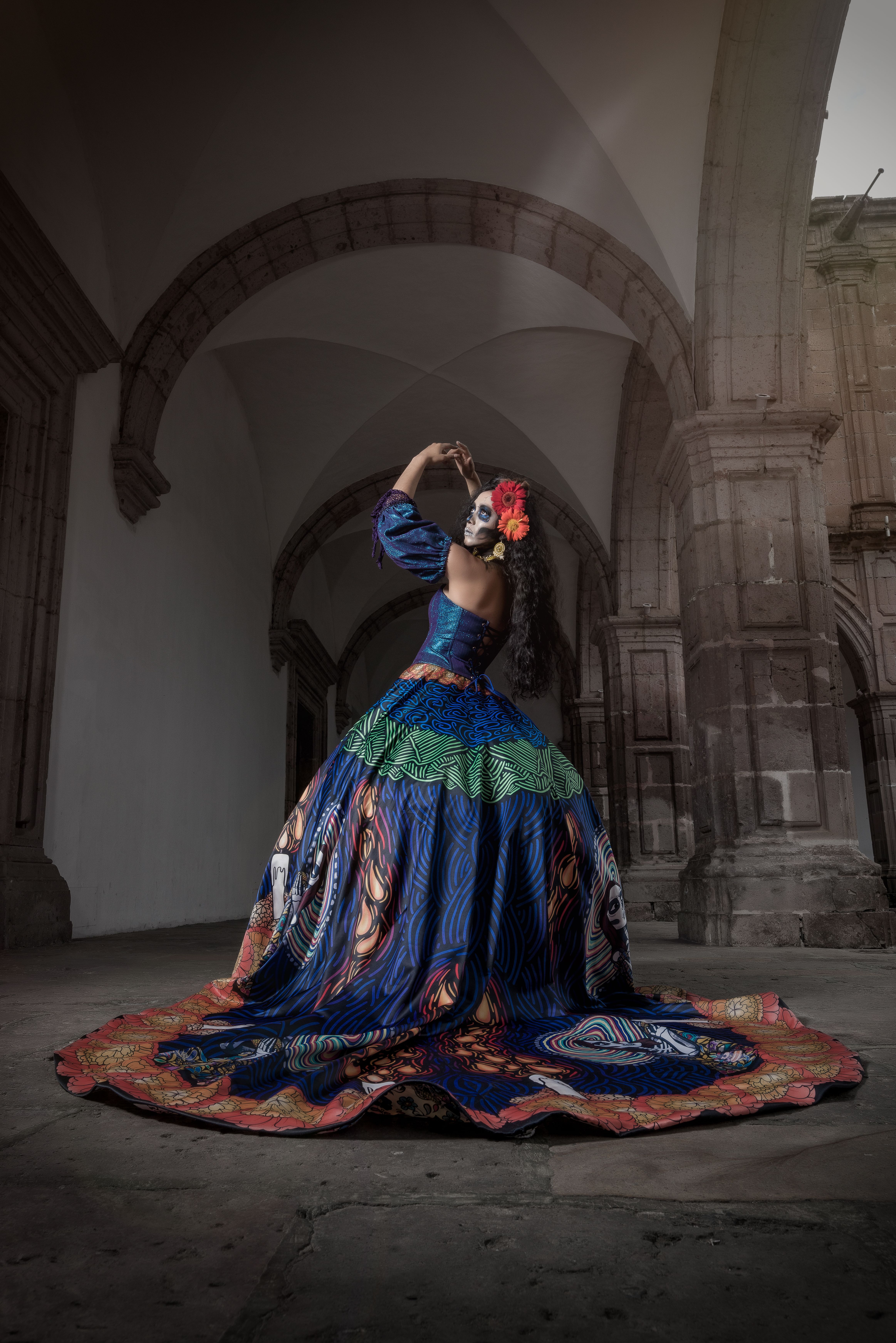 Calavera Catrina in a Ball Gown Standing in an Arcade · Free Stock Photo