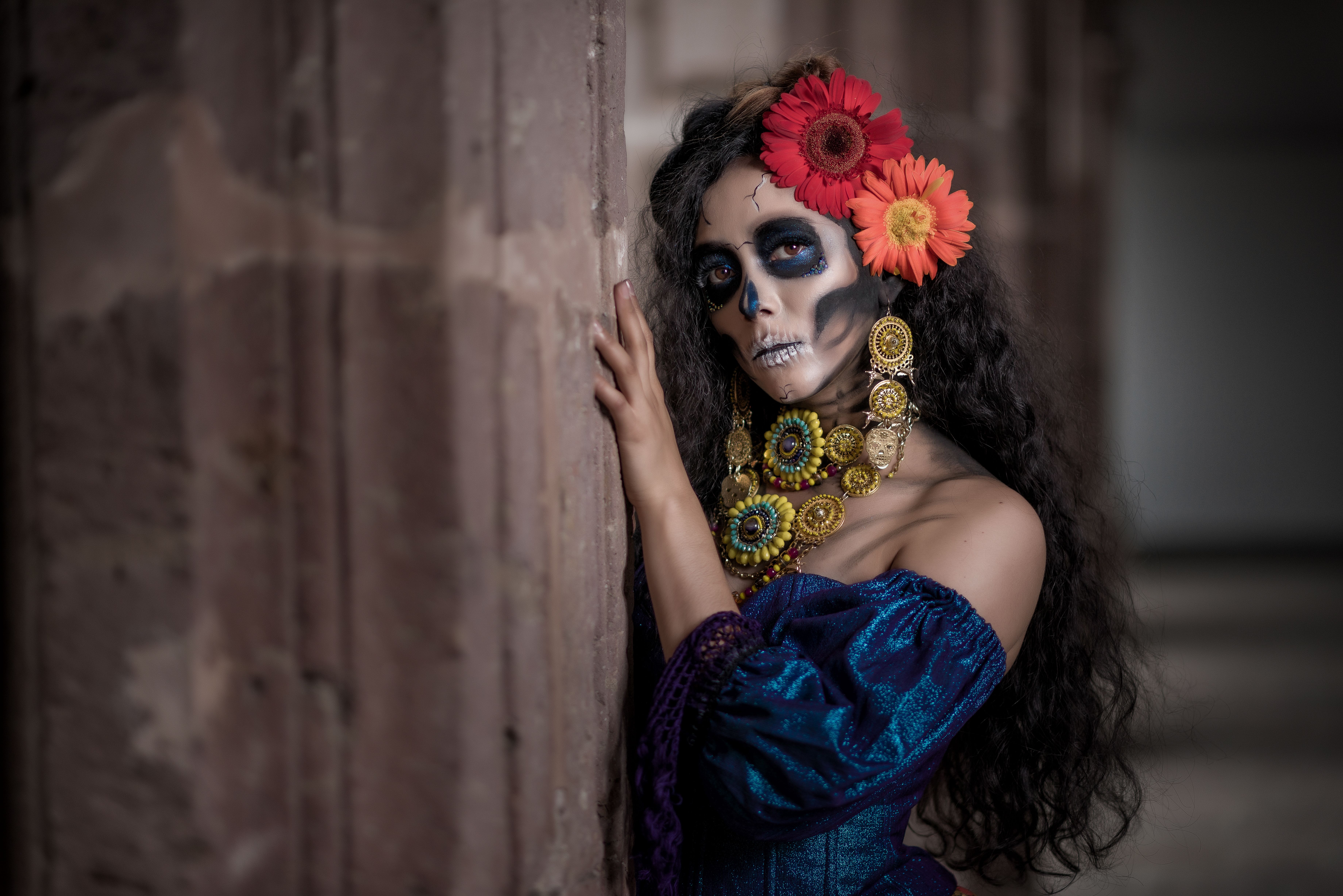 Calavera Catrina in a Blue Dress and Jewelry Posing by a Column · Free ...