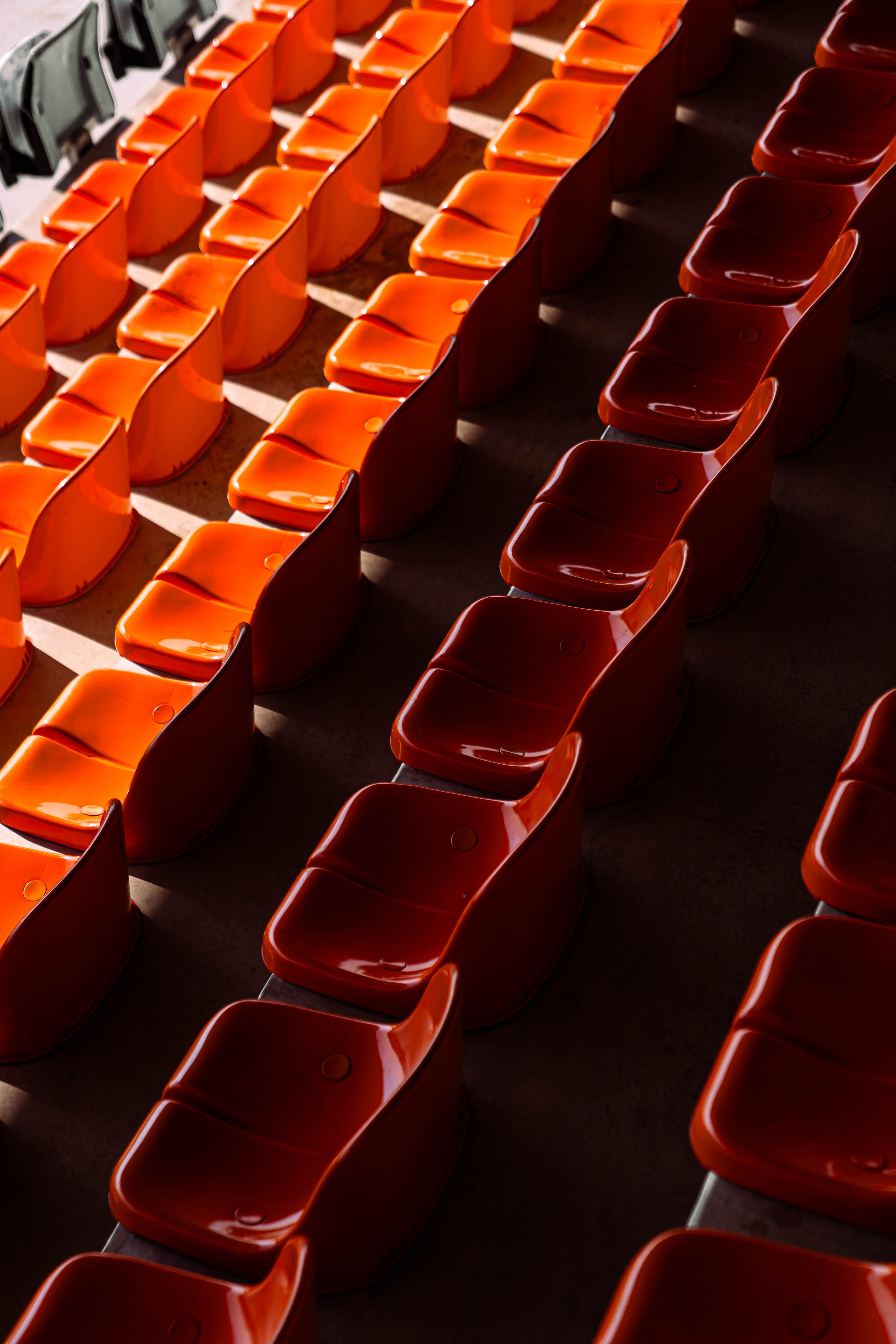 A row of empty orange seats in a stadium · Free Stock Photo