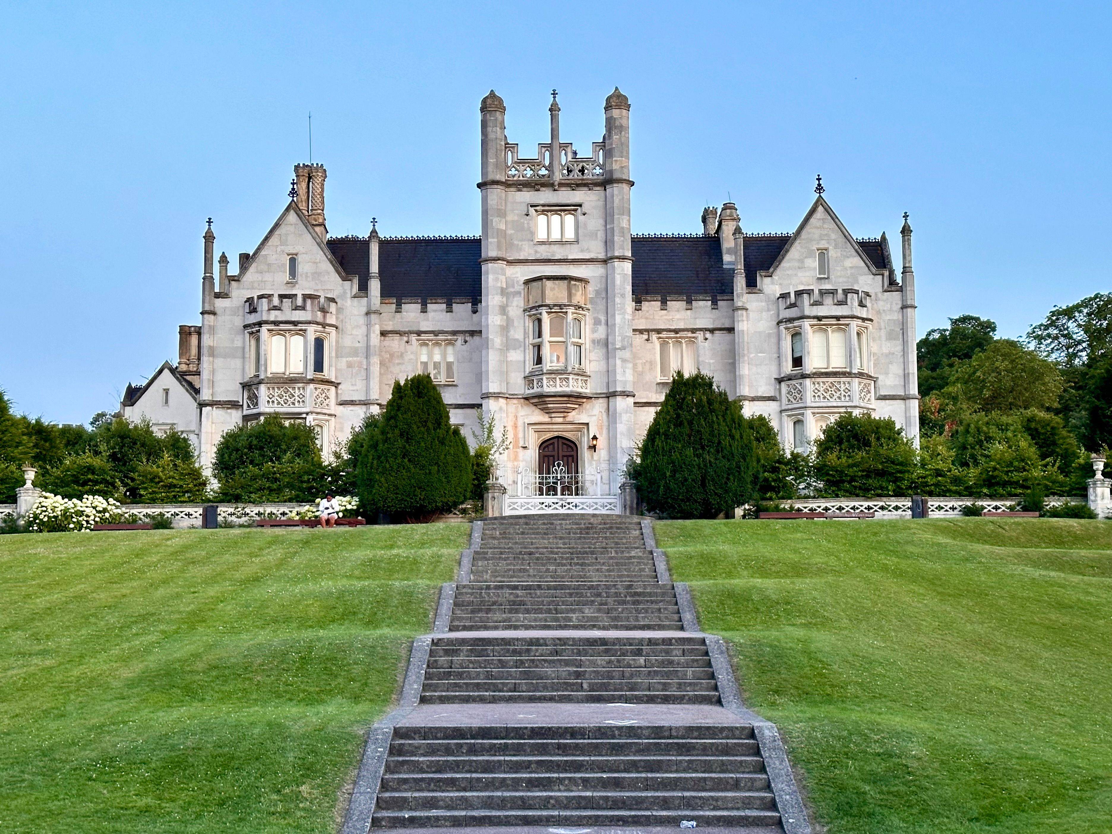 A grand, Gothic-style mansion with intricate stonework, surrounded by ...