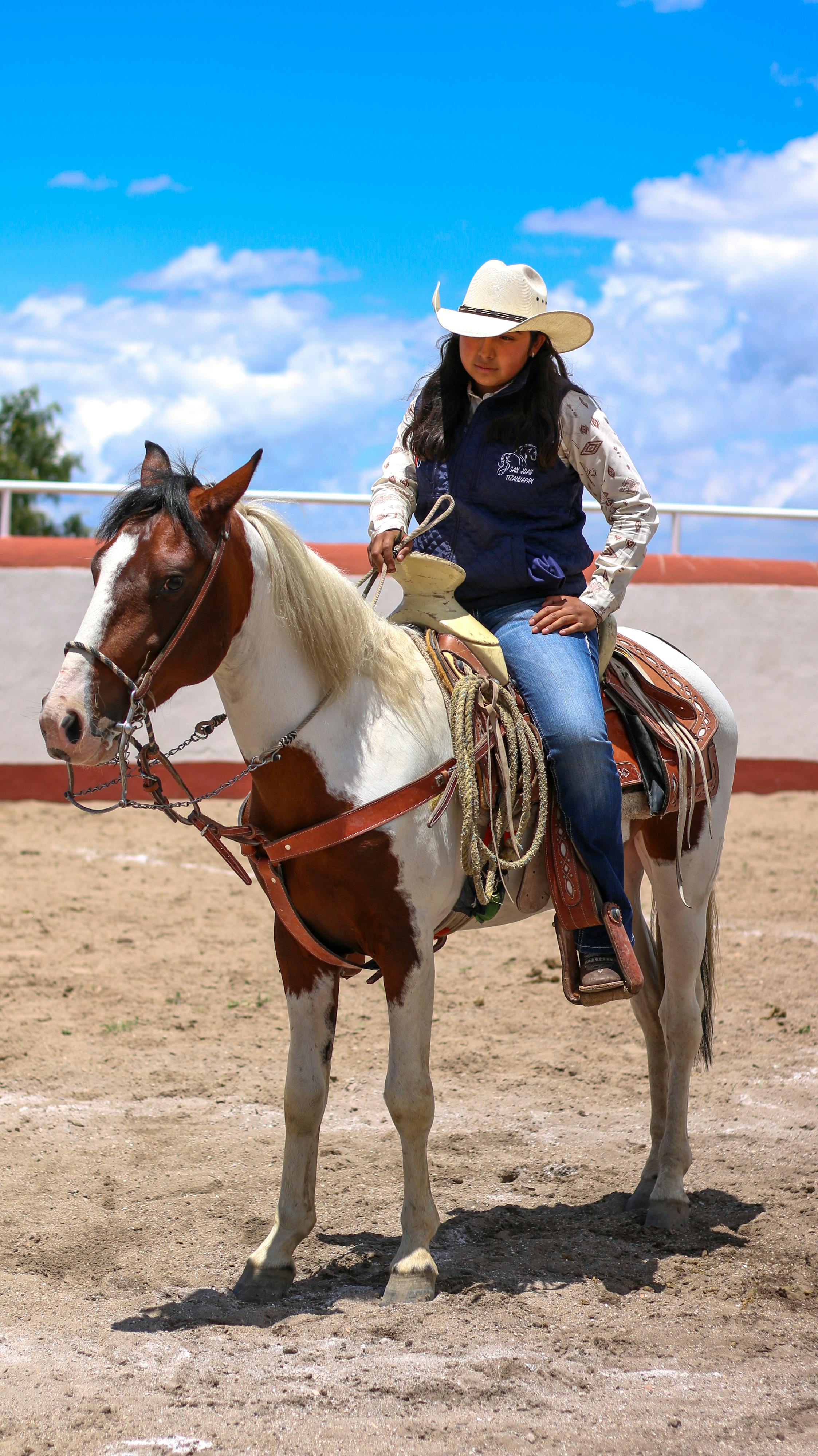 A woman in cowboy hat riding a horse · Free Stock Photo