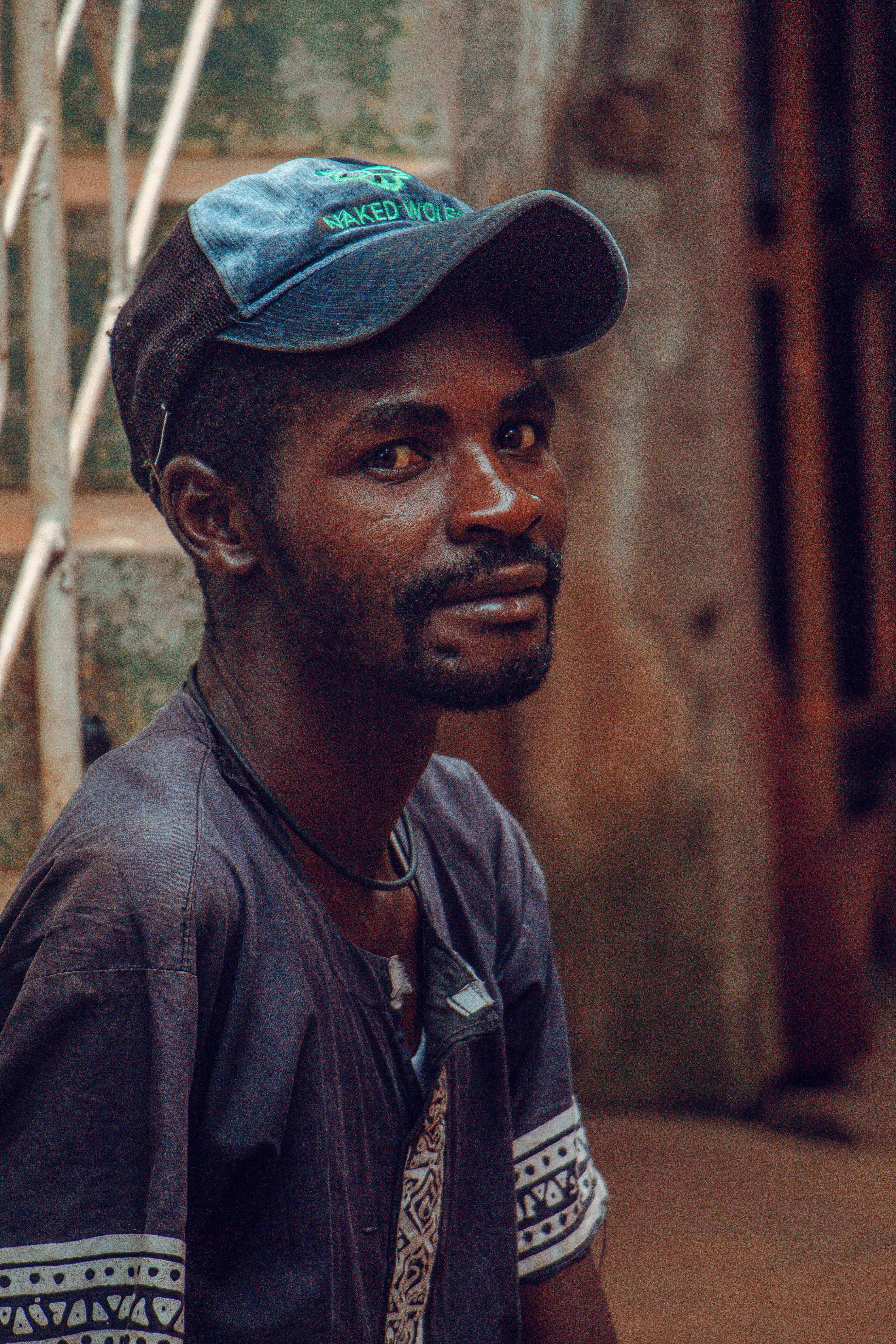 A man with a hat sitting on a bench · Free Stock Photo