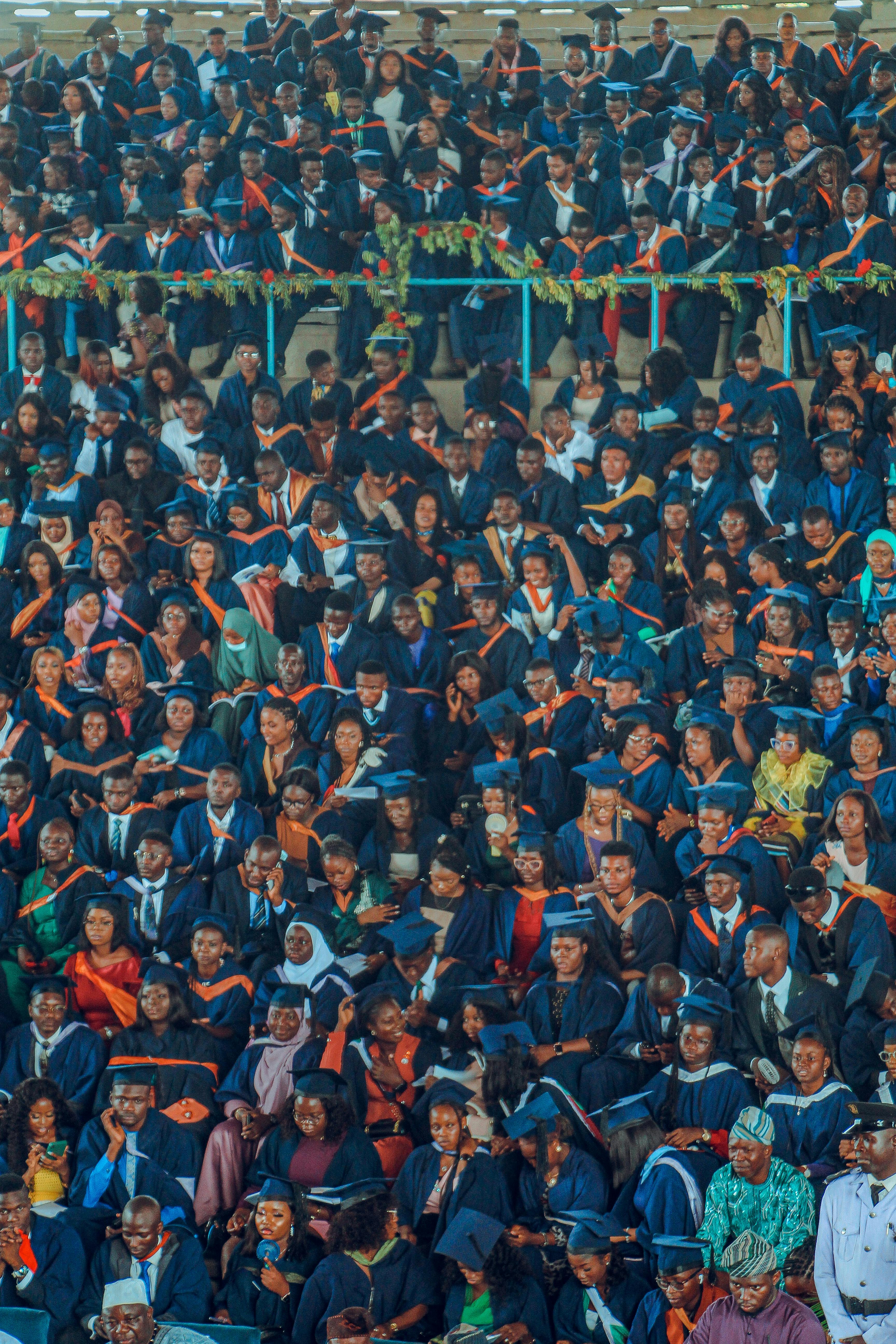 A large crowd of people in graduation caps and gowns · Free Stock Photo