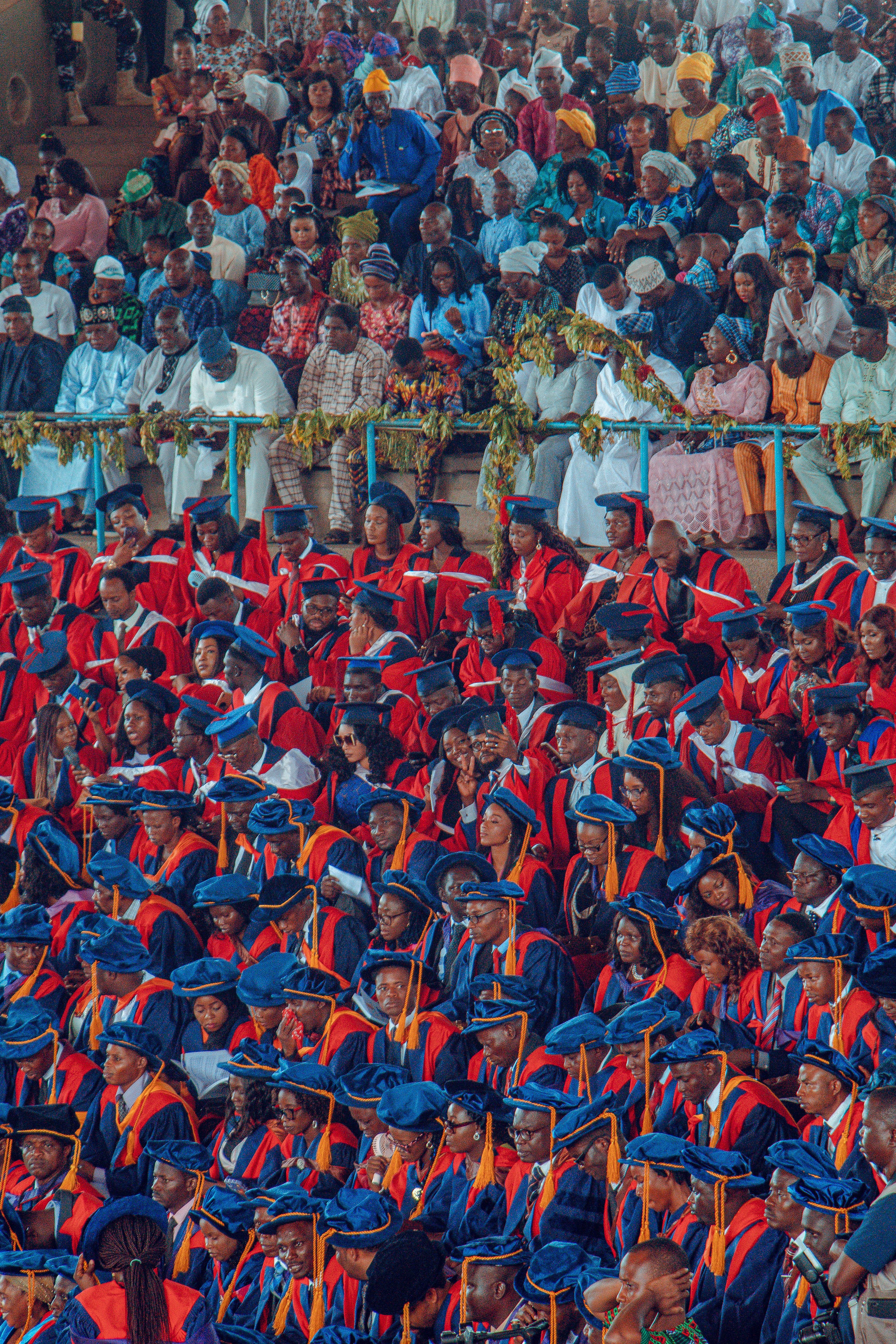 A large crowd of people in graduation caps and gowns · Free Stock Photo