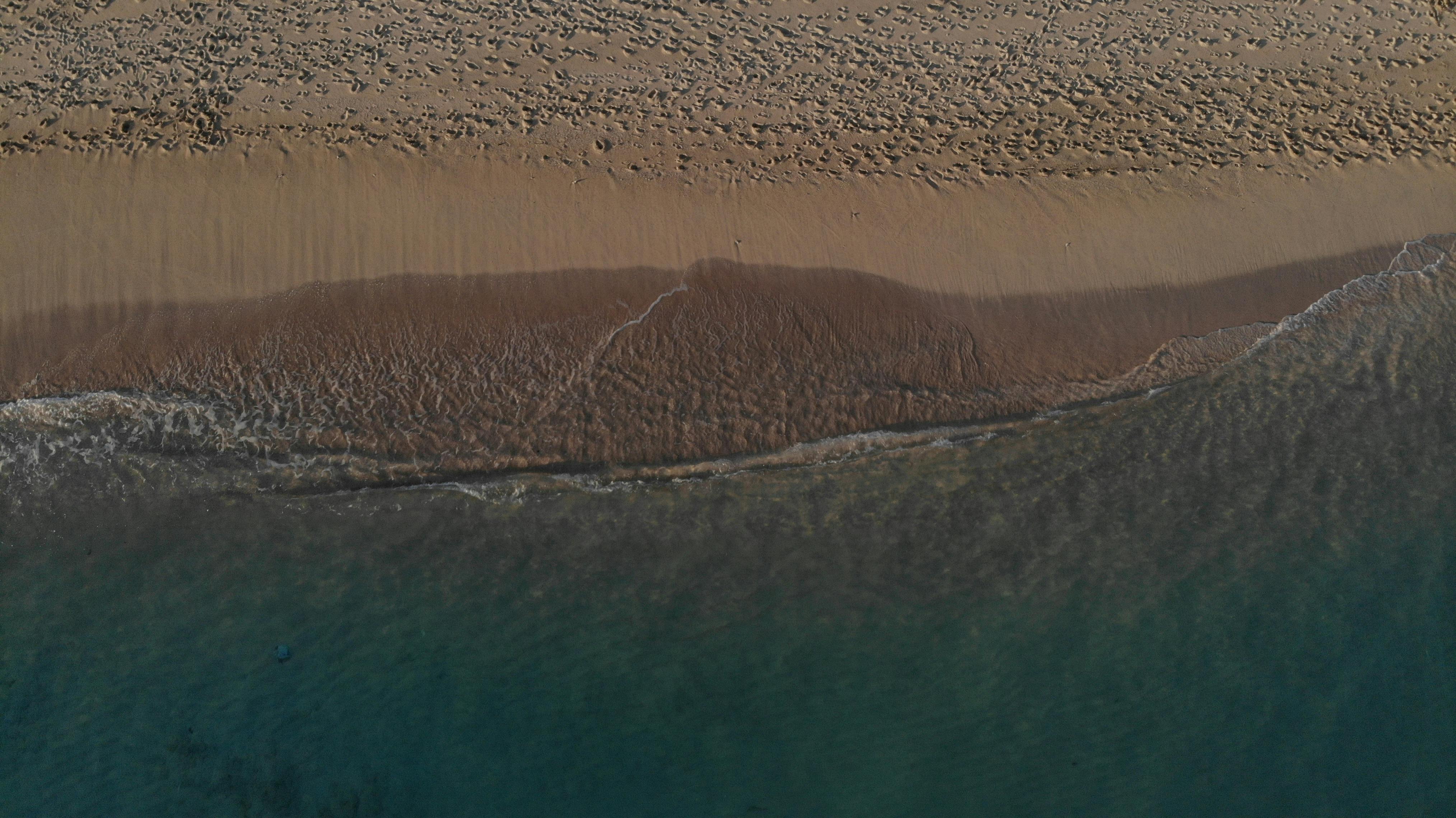 Drone Birds Eye View Top View Half sand, Half water, shore, dusk ...