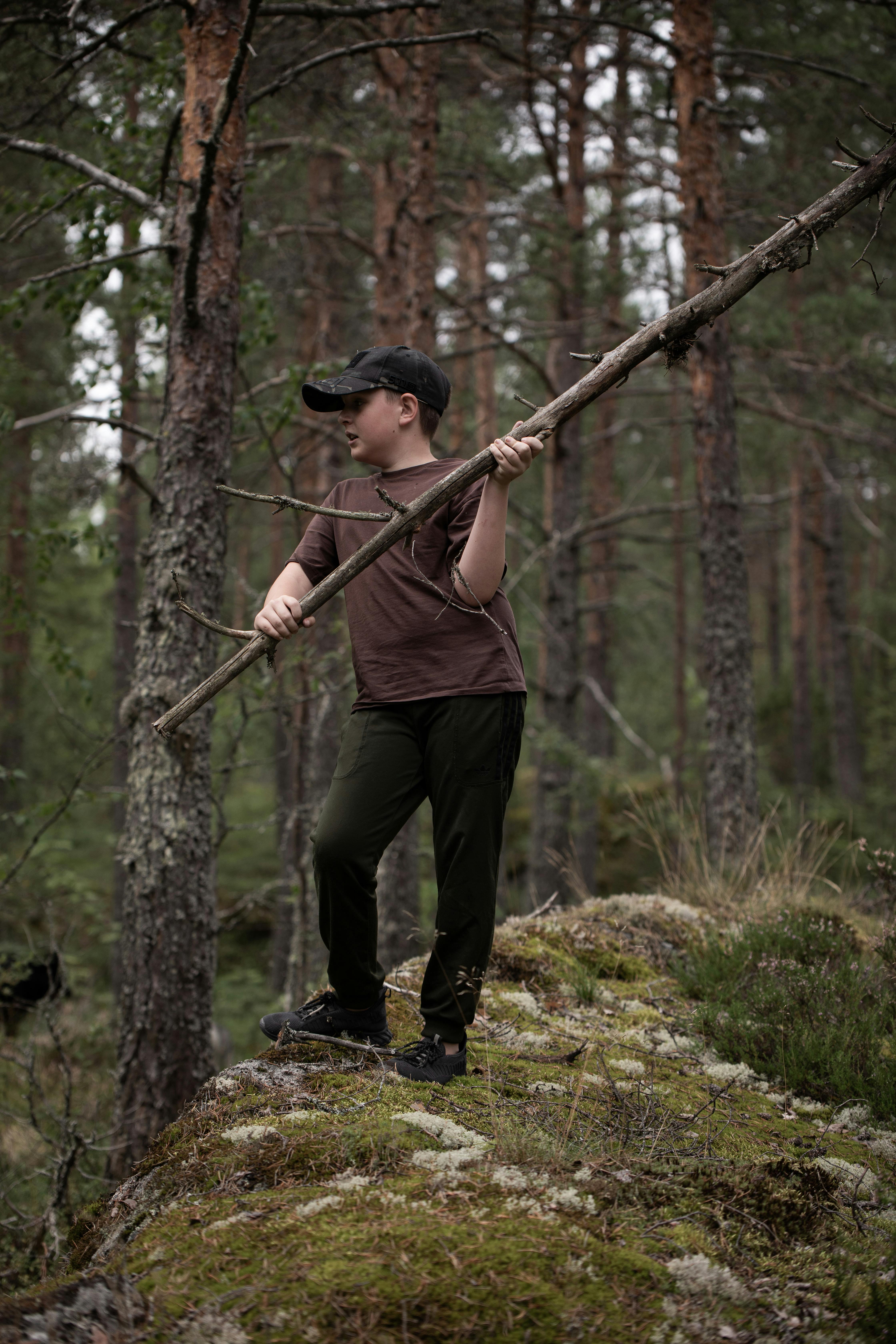 Photo of Man Sitting on Rock Near Lake · Free Stock Photo