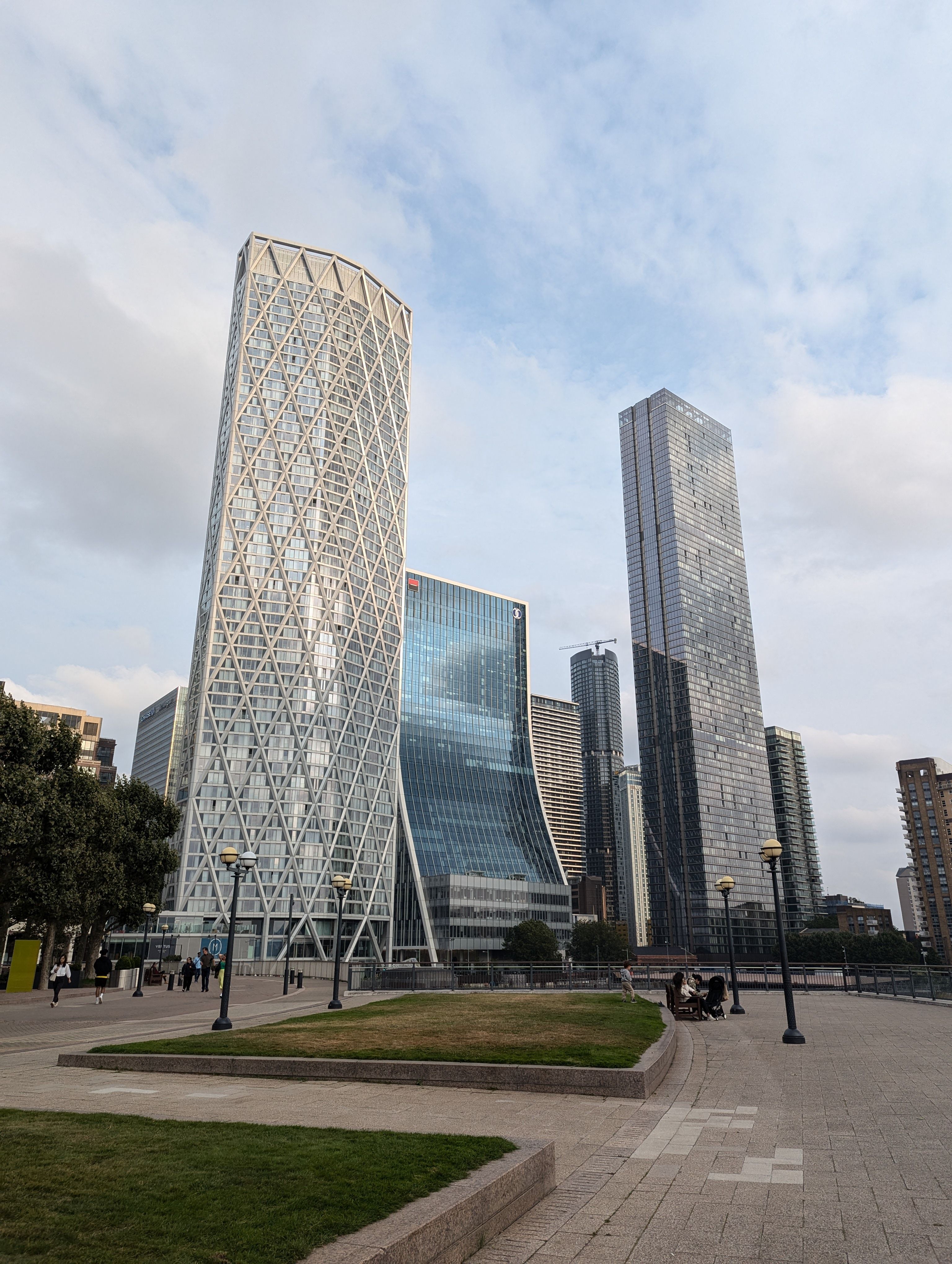 Two tall buildings with glass windows and a walkway · Free Stock Photo