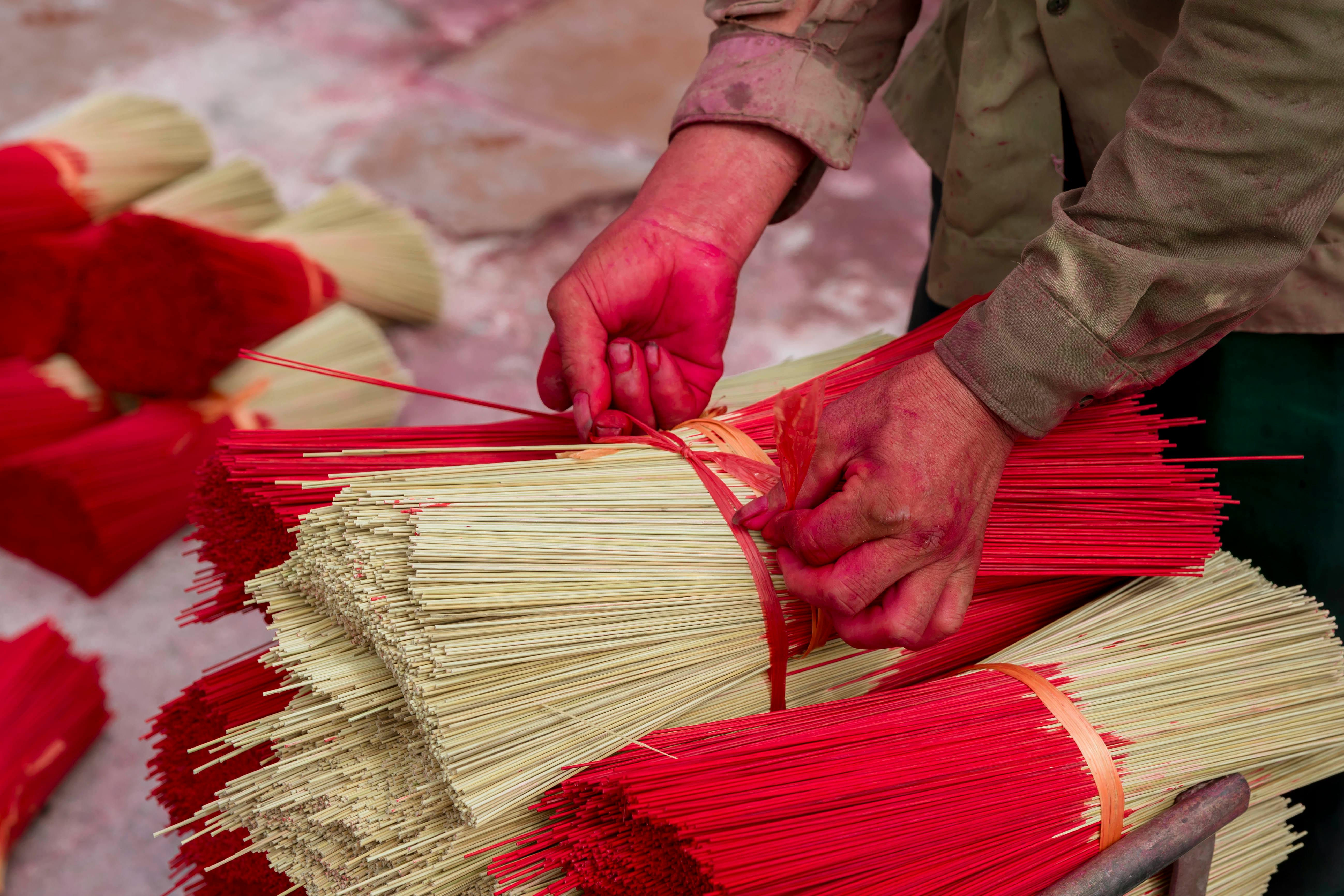 A person is cutting up red sticks with red and white sticks · Free ...