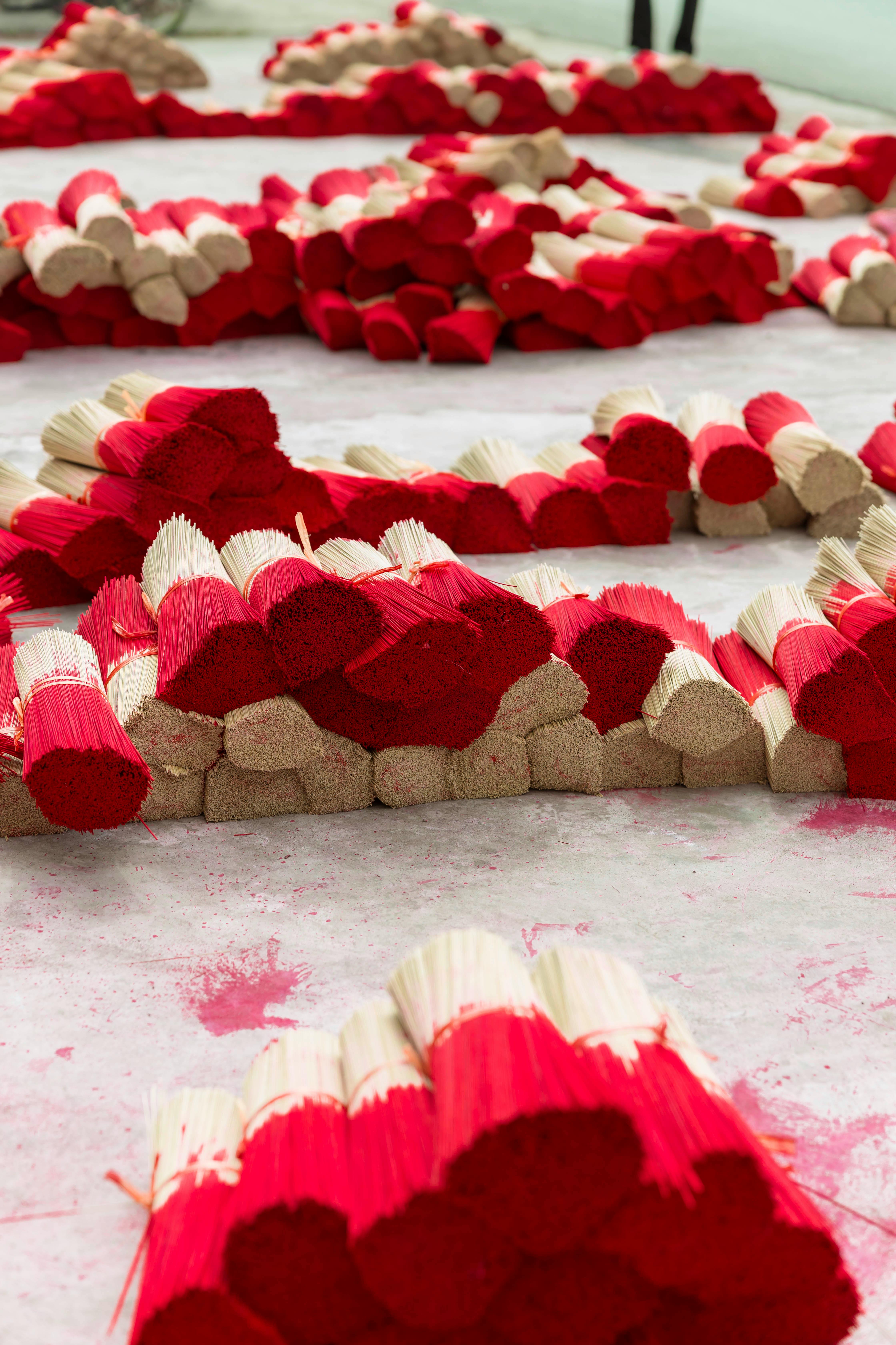 A pile of red and white sticks on a table · Free Stock Photo