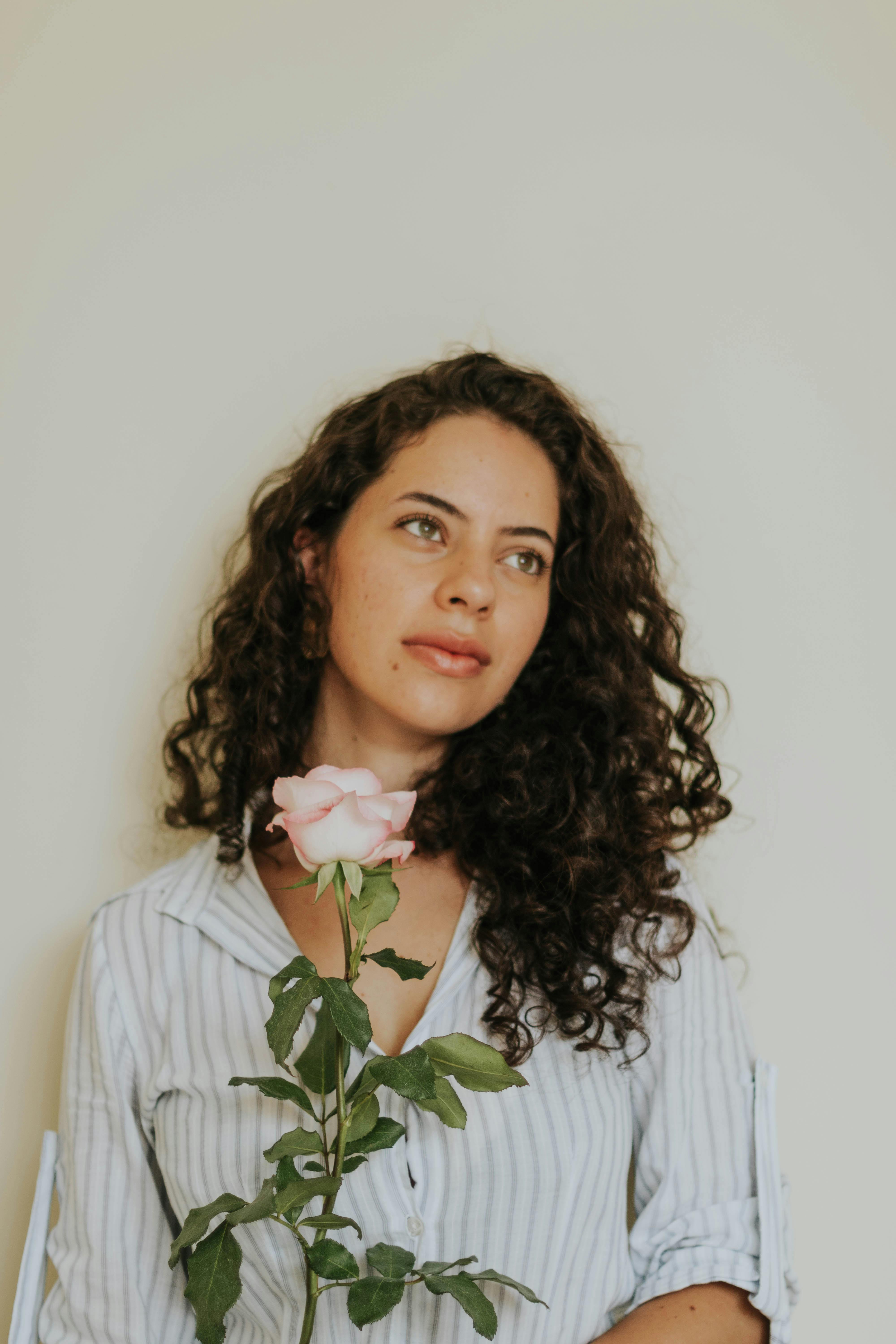 Portrait of Brunette Woman Holding Pink Rose · Free Stock Photo