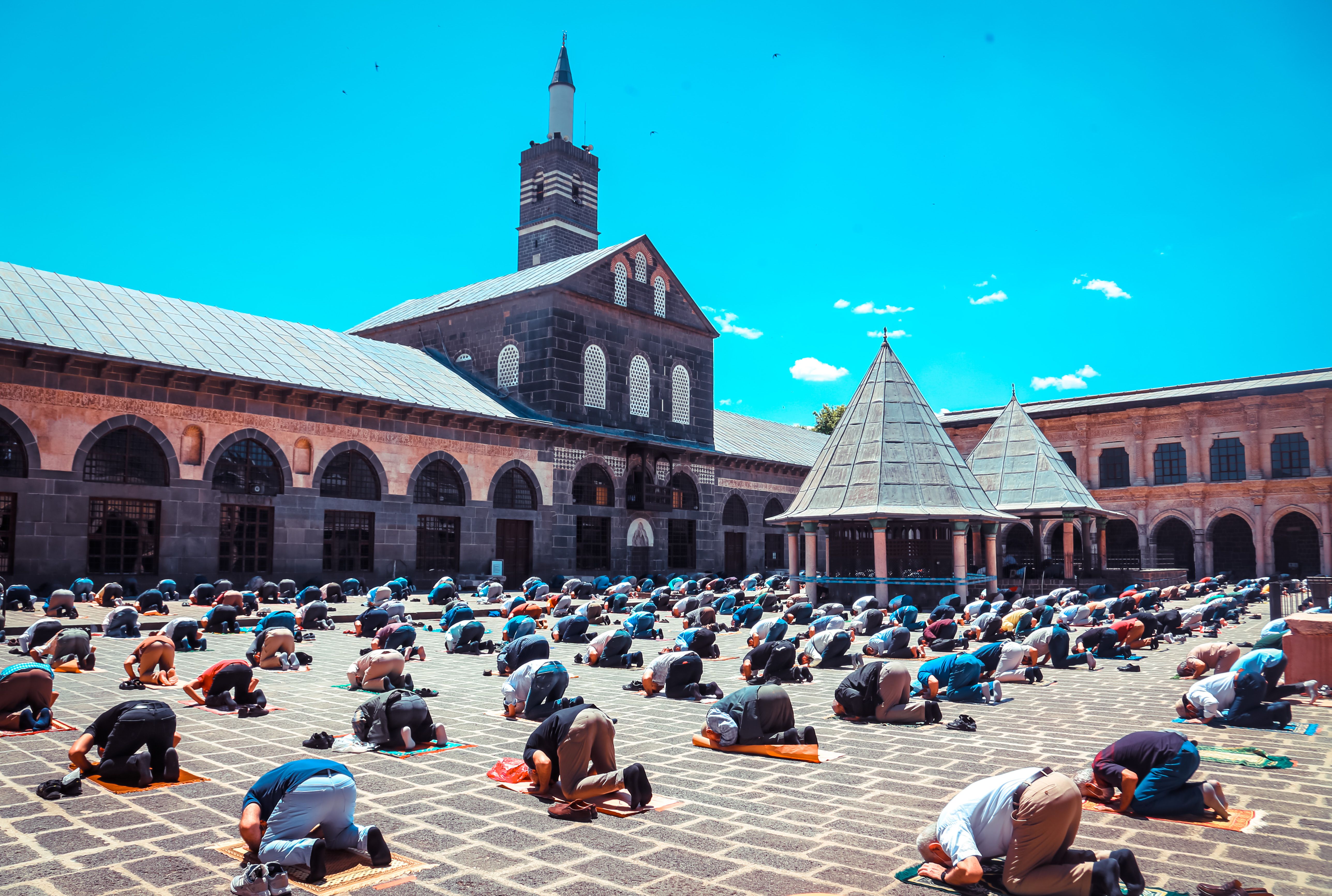 People are doing yoga in a courtyard with a church · Free Stock Photo