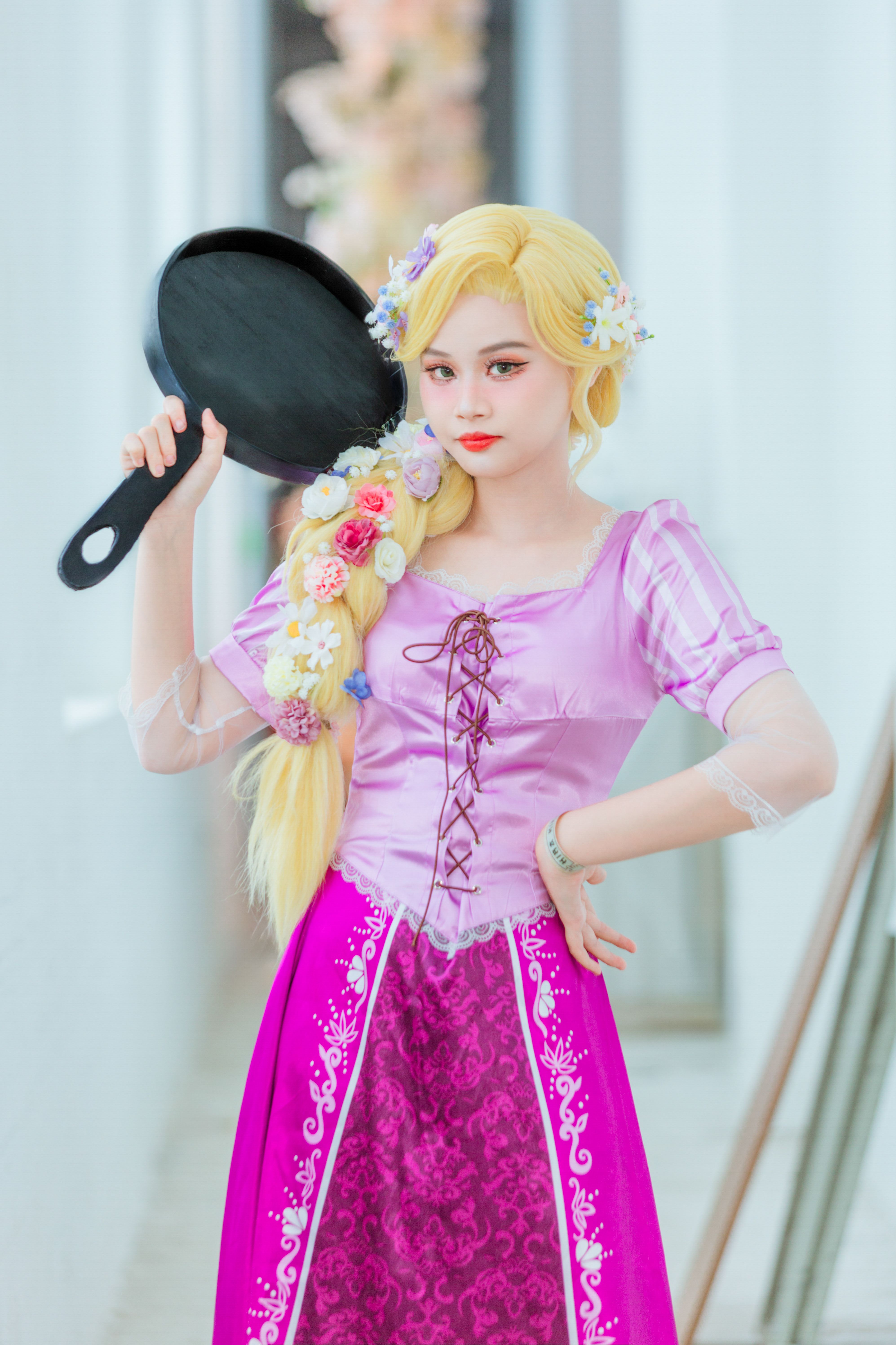A woman in a princess costume holding a frying pan · Free Stock Photo