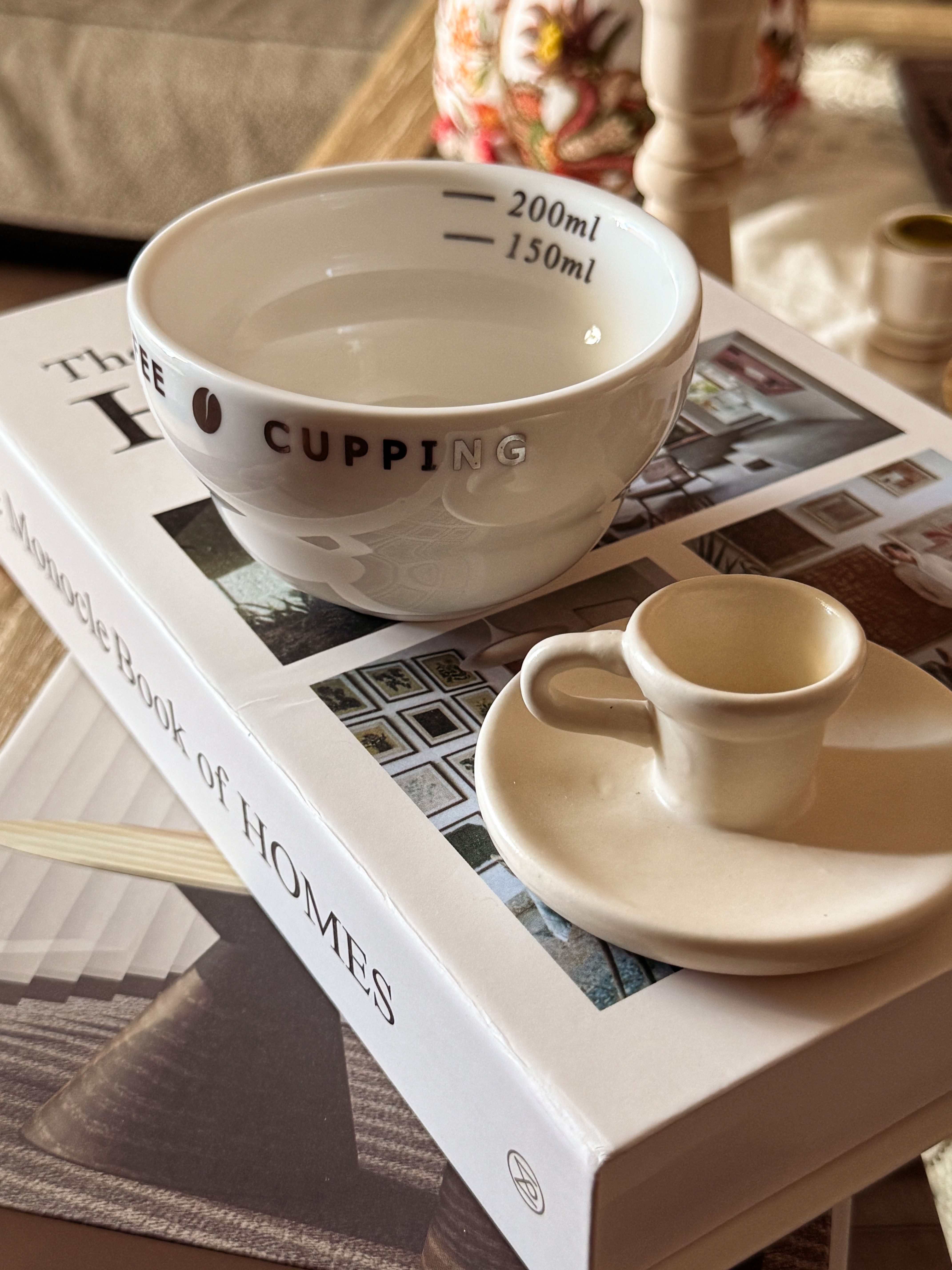 A book with a cup and saucer on top of it · Free Stock Photo