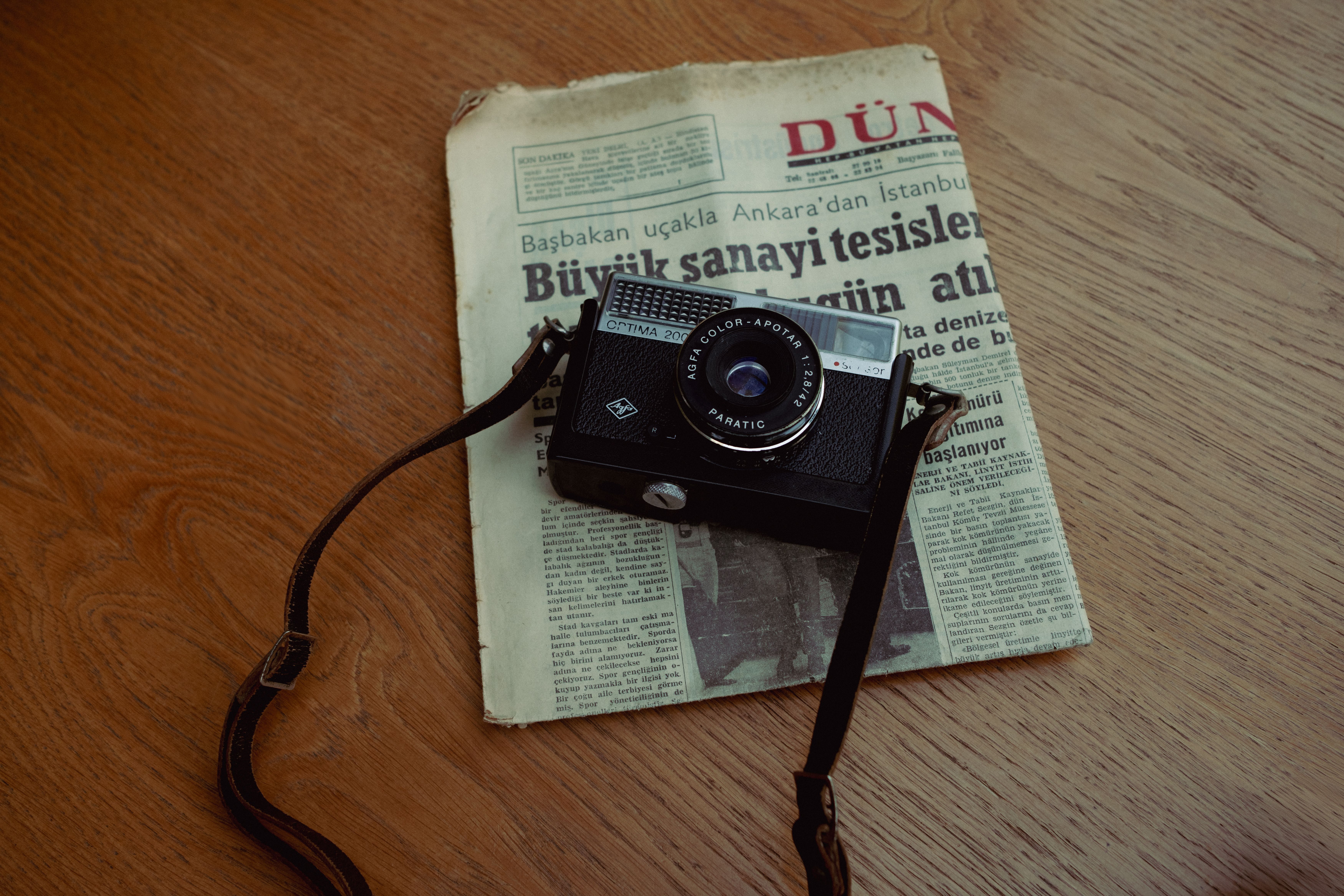 A camera on a newspaper · Free Stock Photo