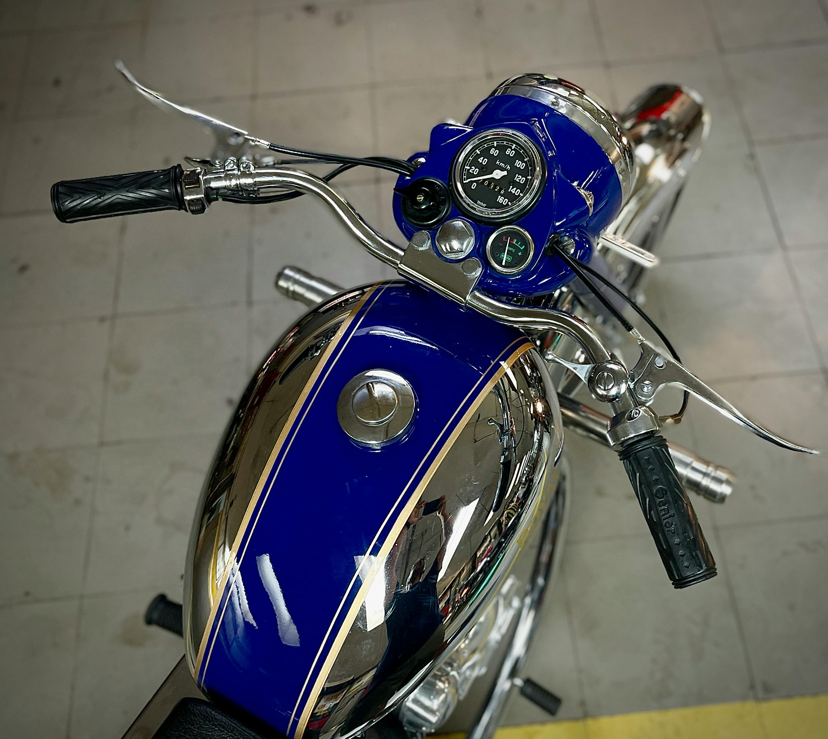 A close up of a blue motorcycle with a silver handlebar · Free Stock Photo