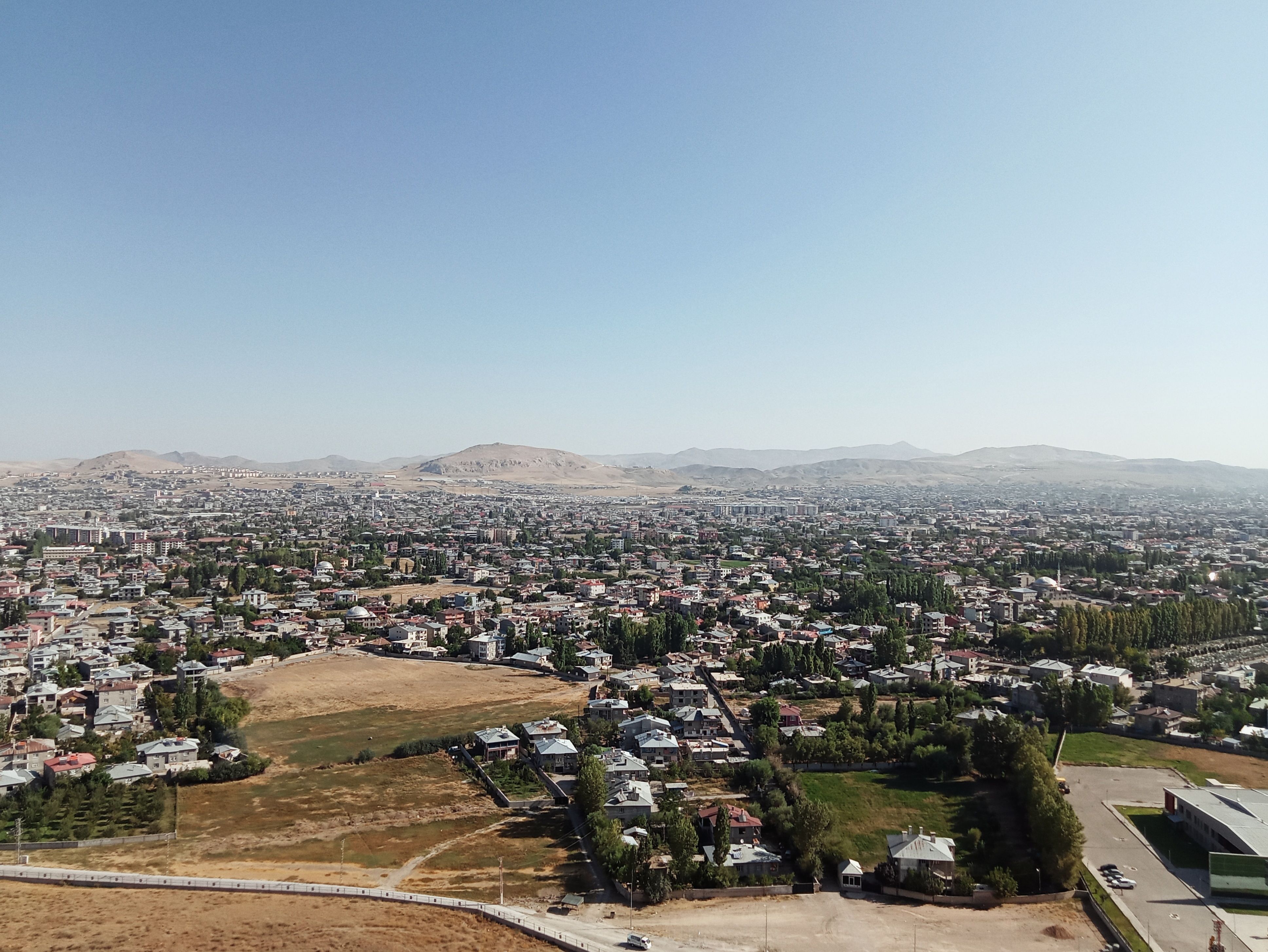 Aerial view of a city with a large green area · Free Stock Photo
