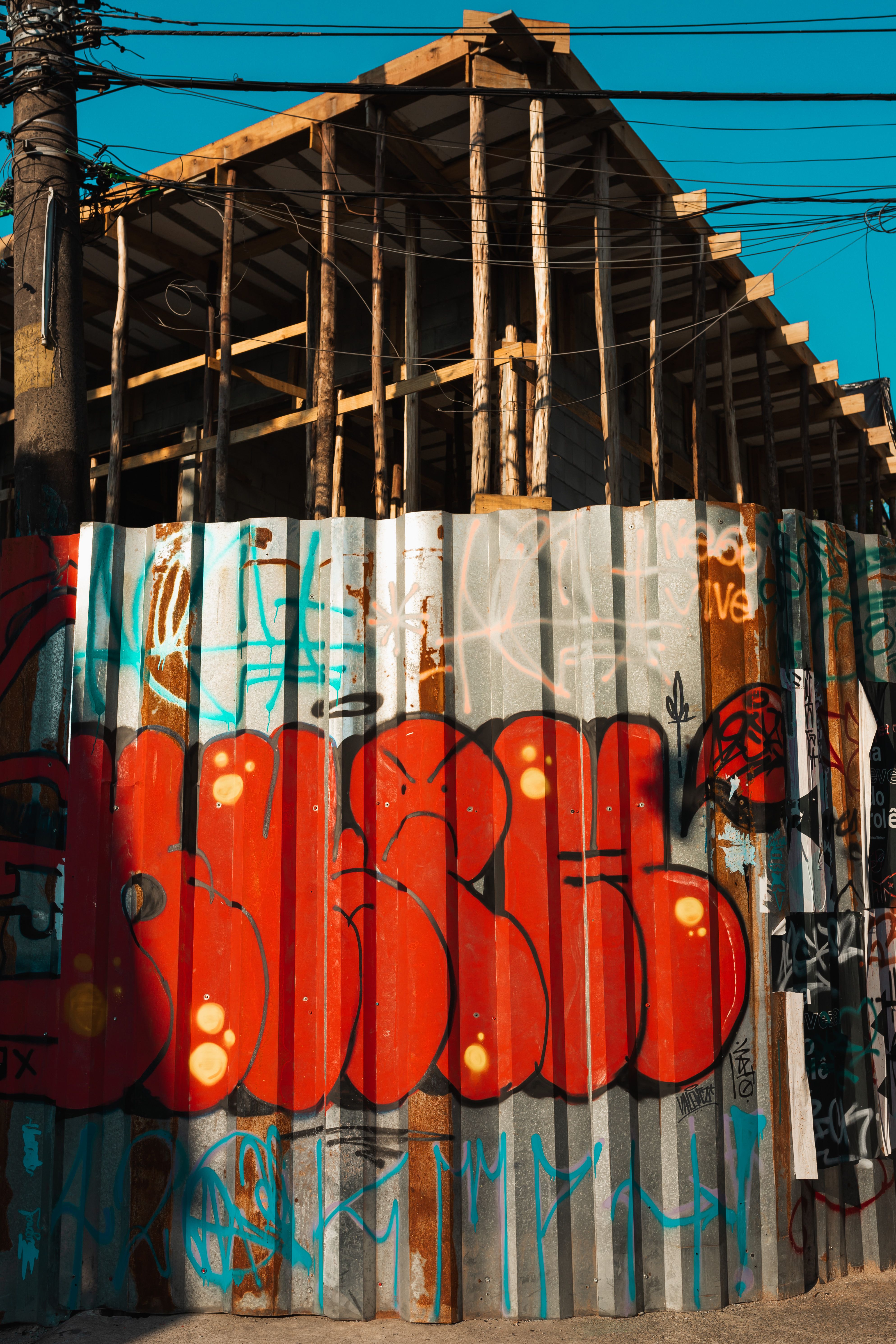A graffiti covered fence with a blue sky in the background · Free Stock ...