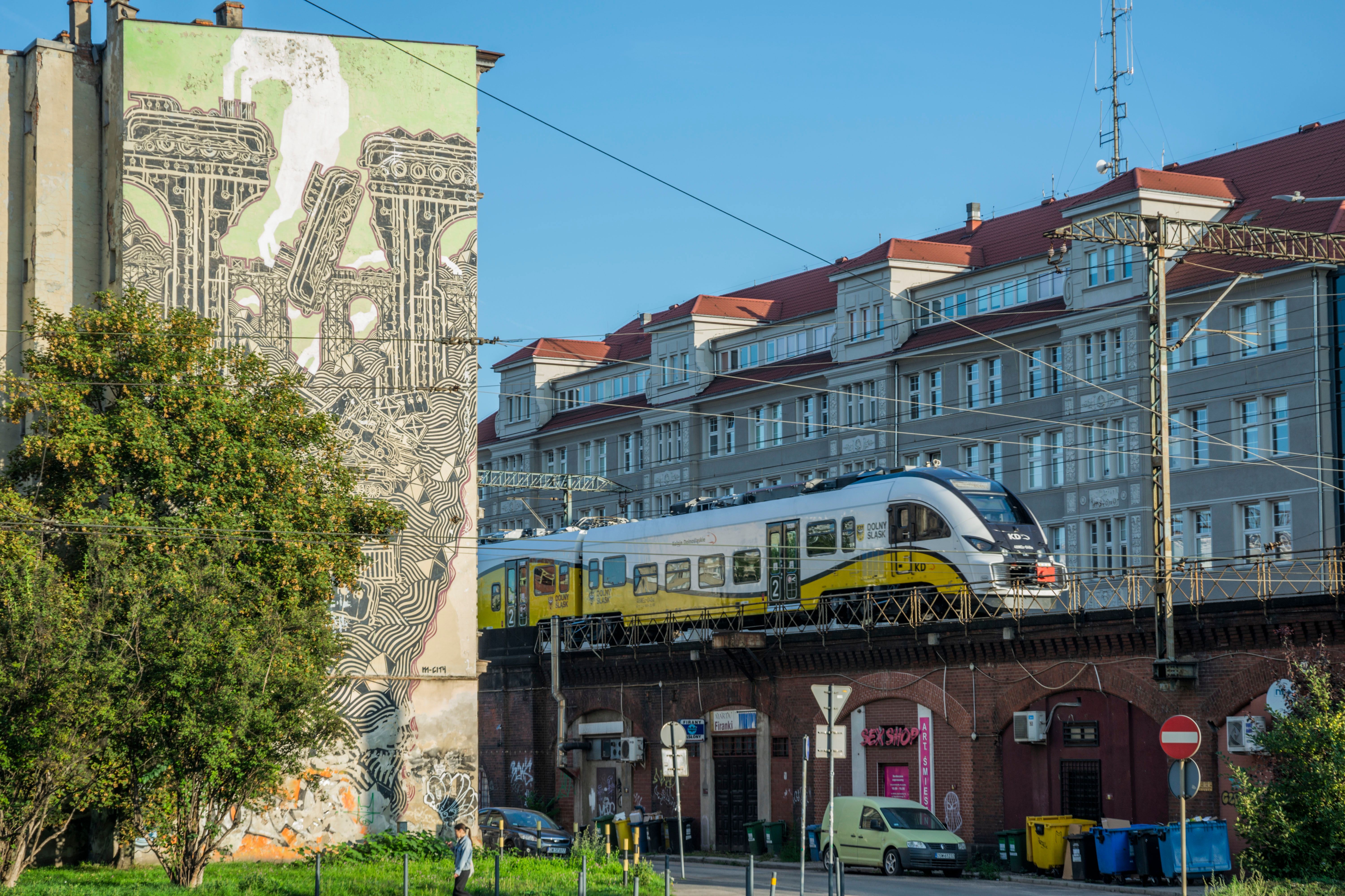 A moving train in Wroclaw Poland city streets bridge · Free Stock Photo