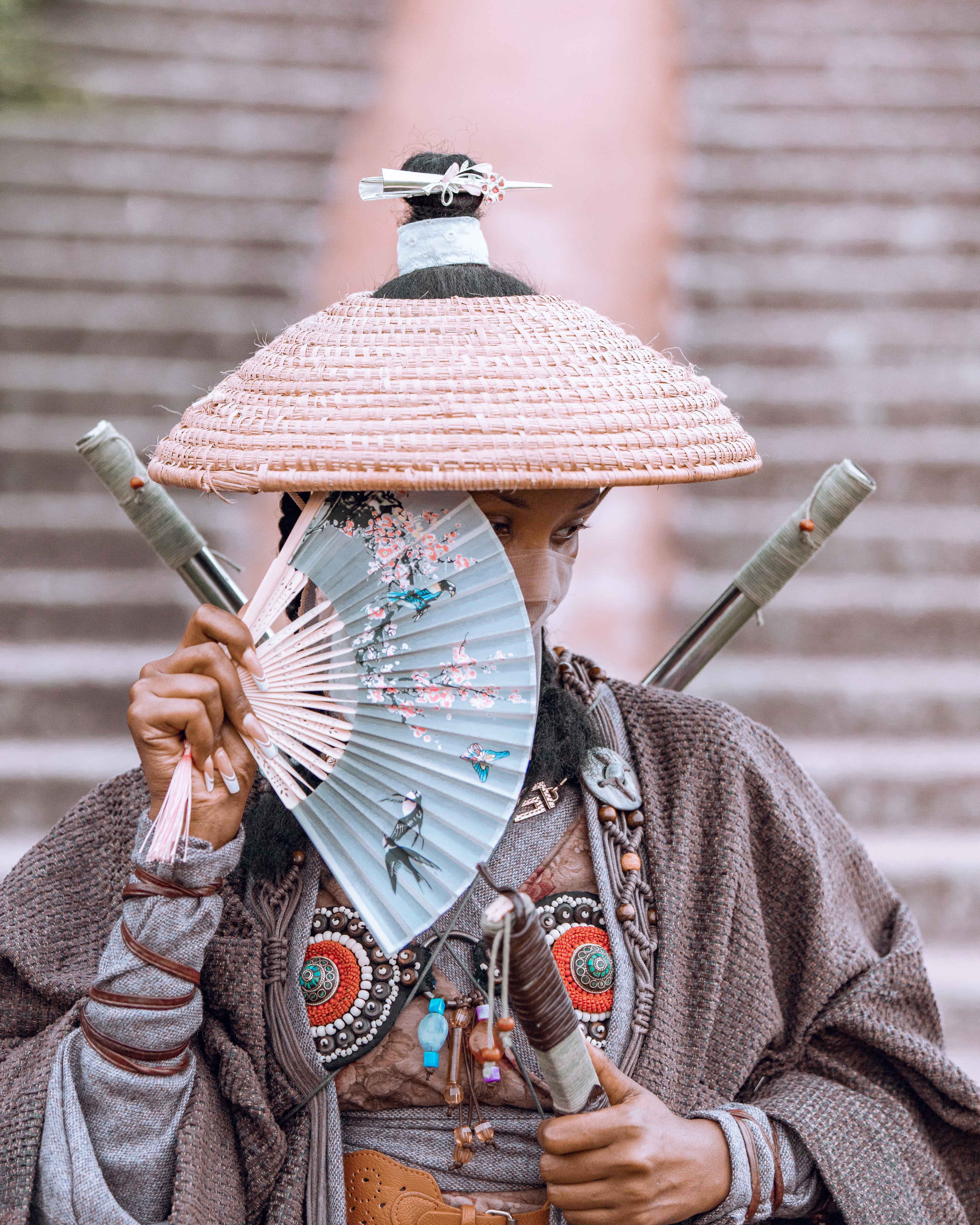 A woman in traditional clothing holding a fan · Free Stock Photo