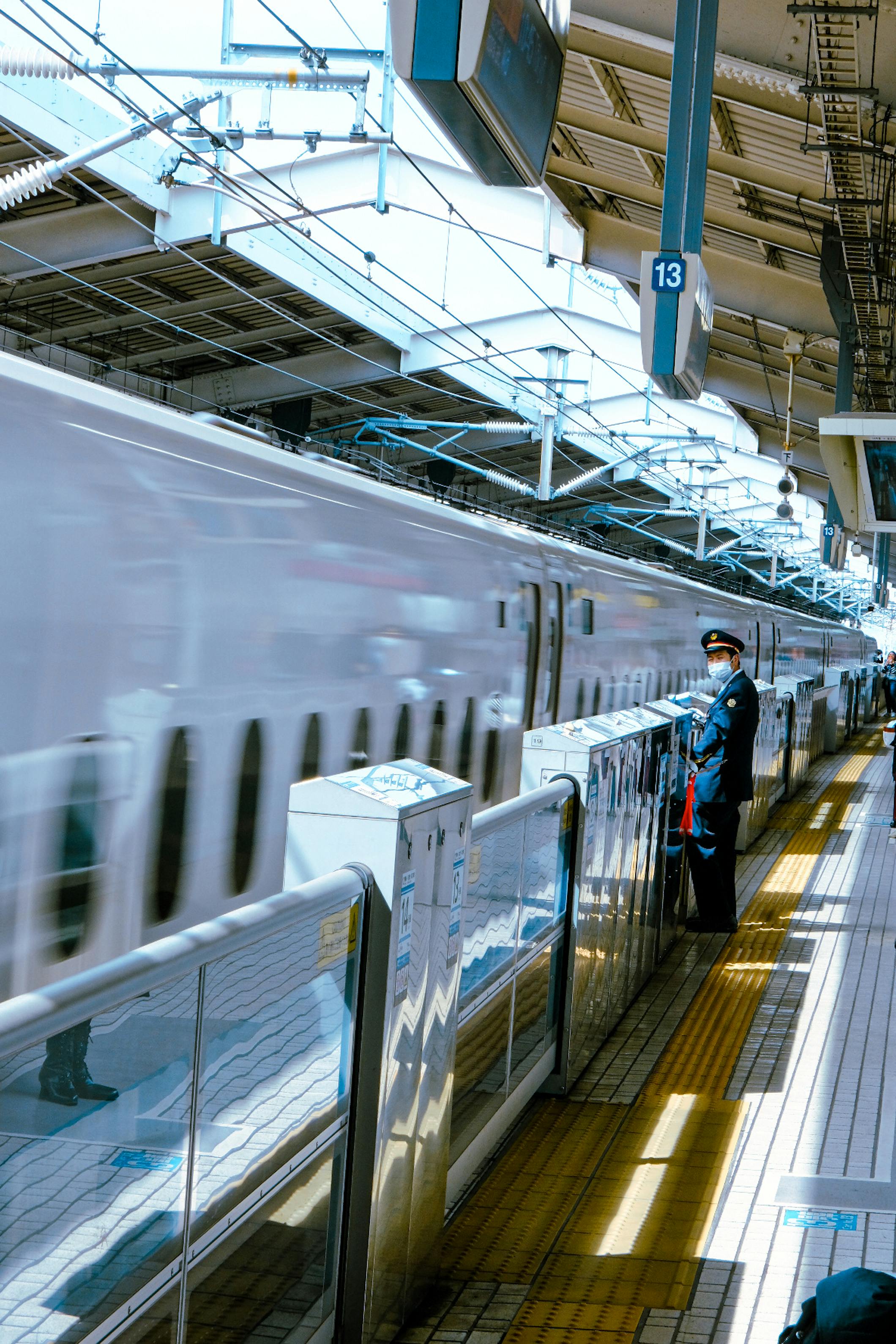 A person standing on the platform of a train · Free Stock Photo
