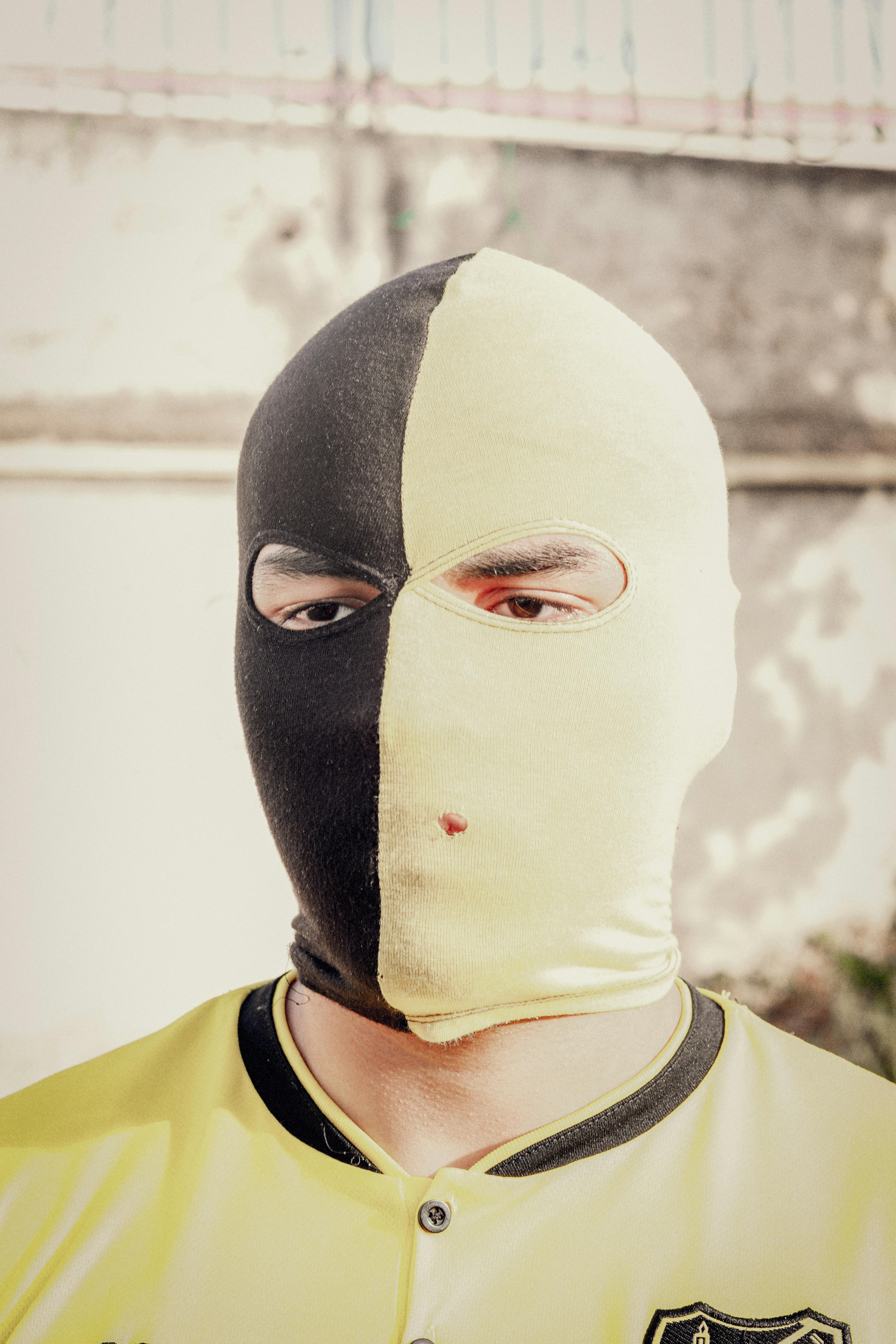 A man in a yellow and black mask · Free Stock Photo