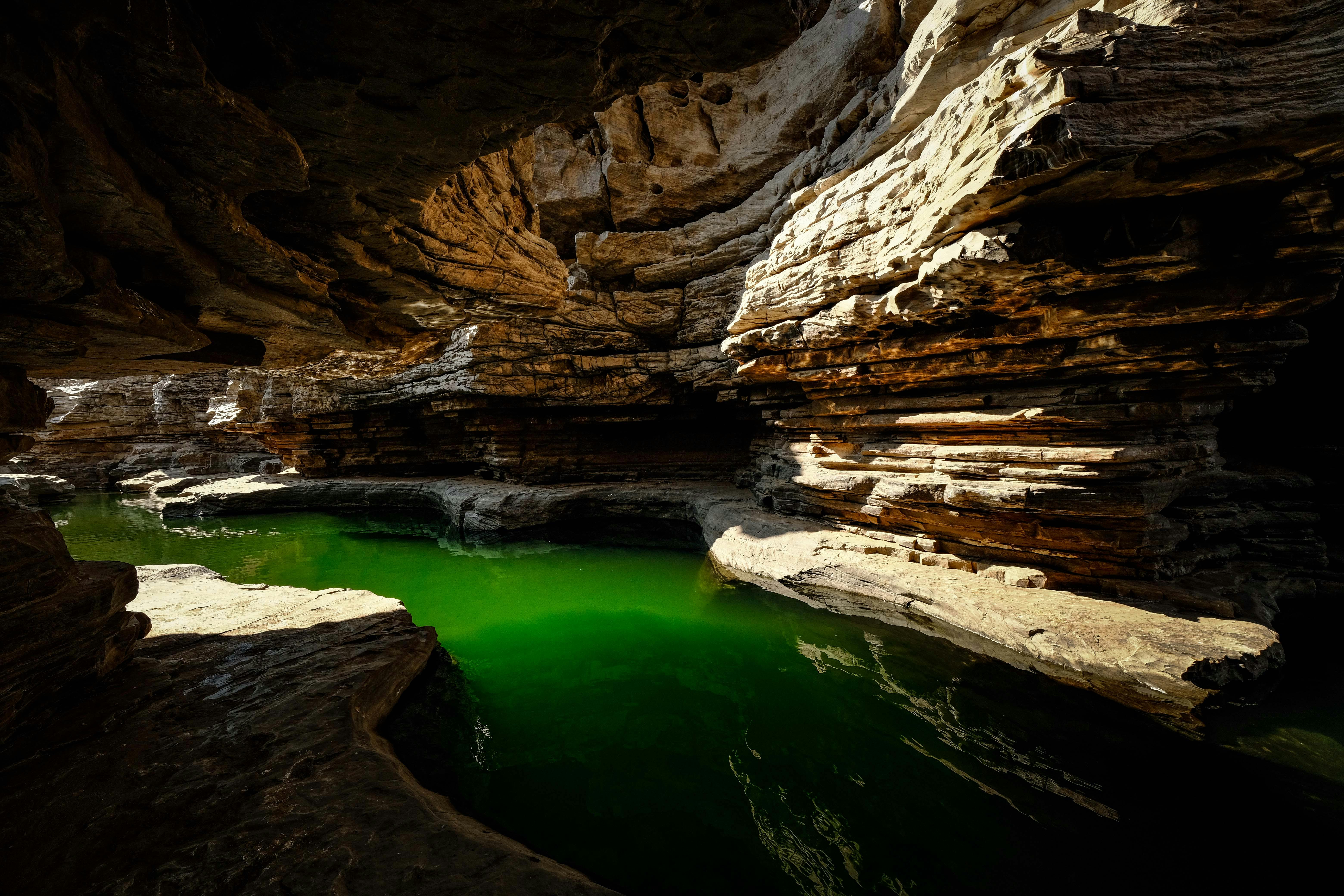 A green pool in a cave with water · Free Stock Photo