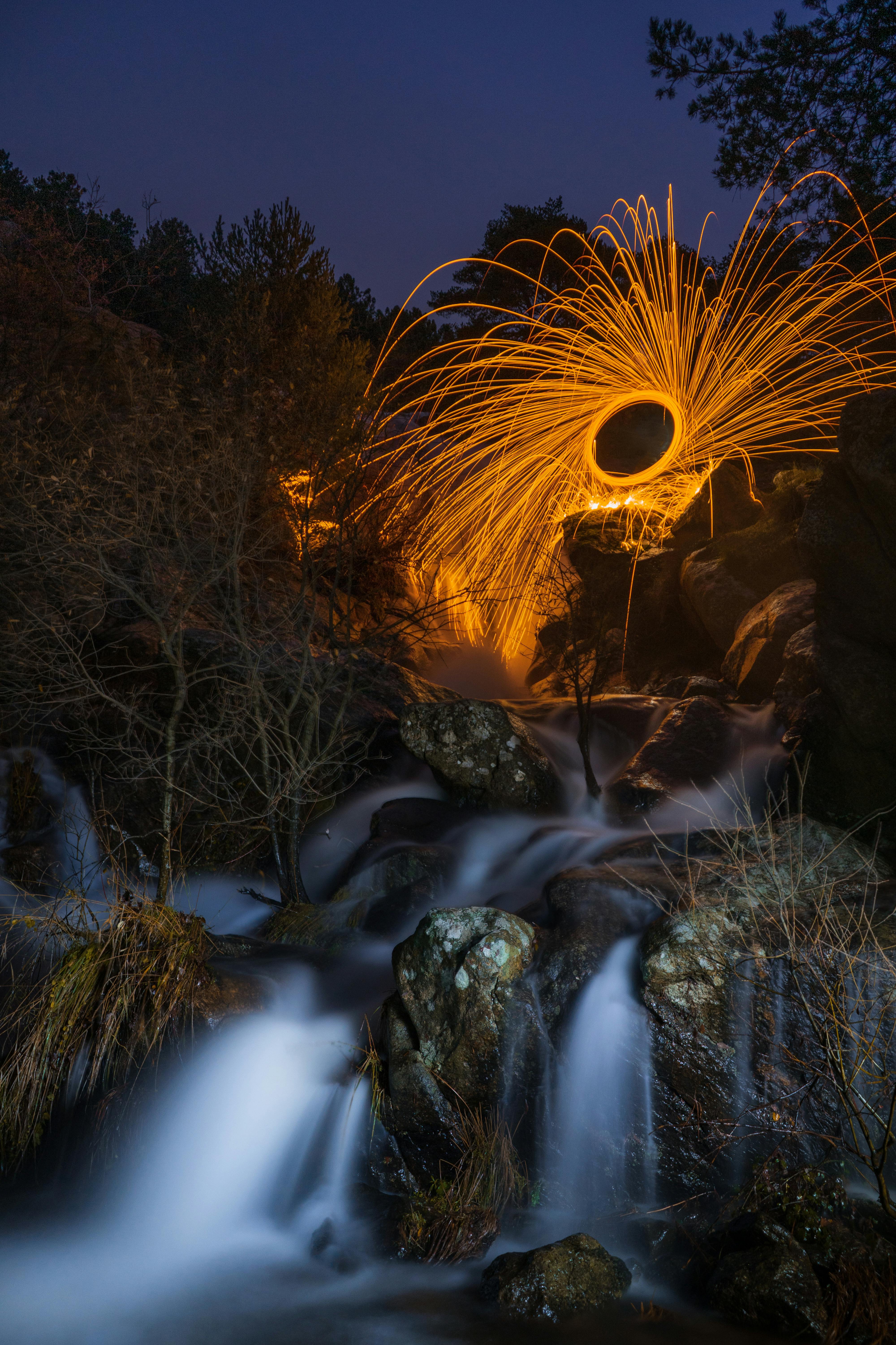 A firework is lit up in the middle of a stream · Free Stock Photo
