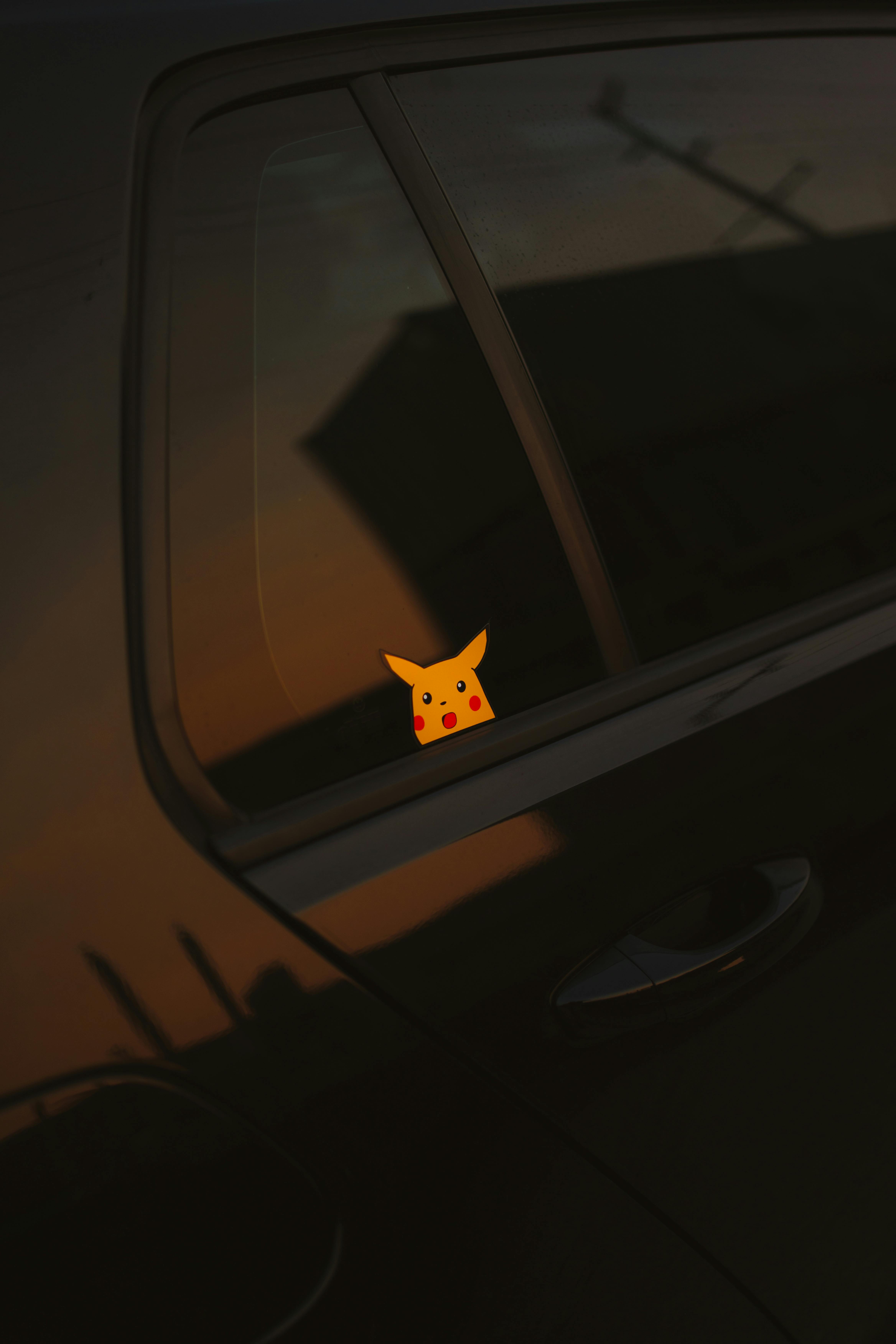 A car window sticker with a pokemon sticker on it · Free Stock Photo