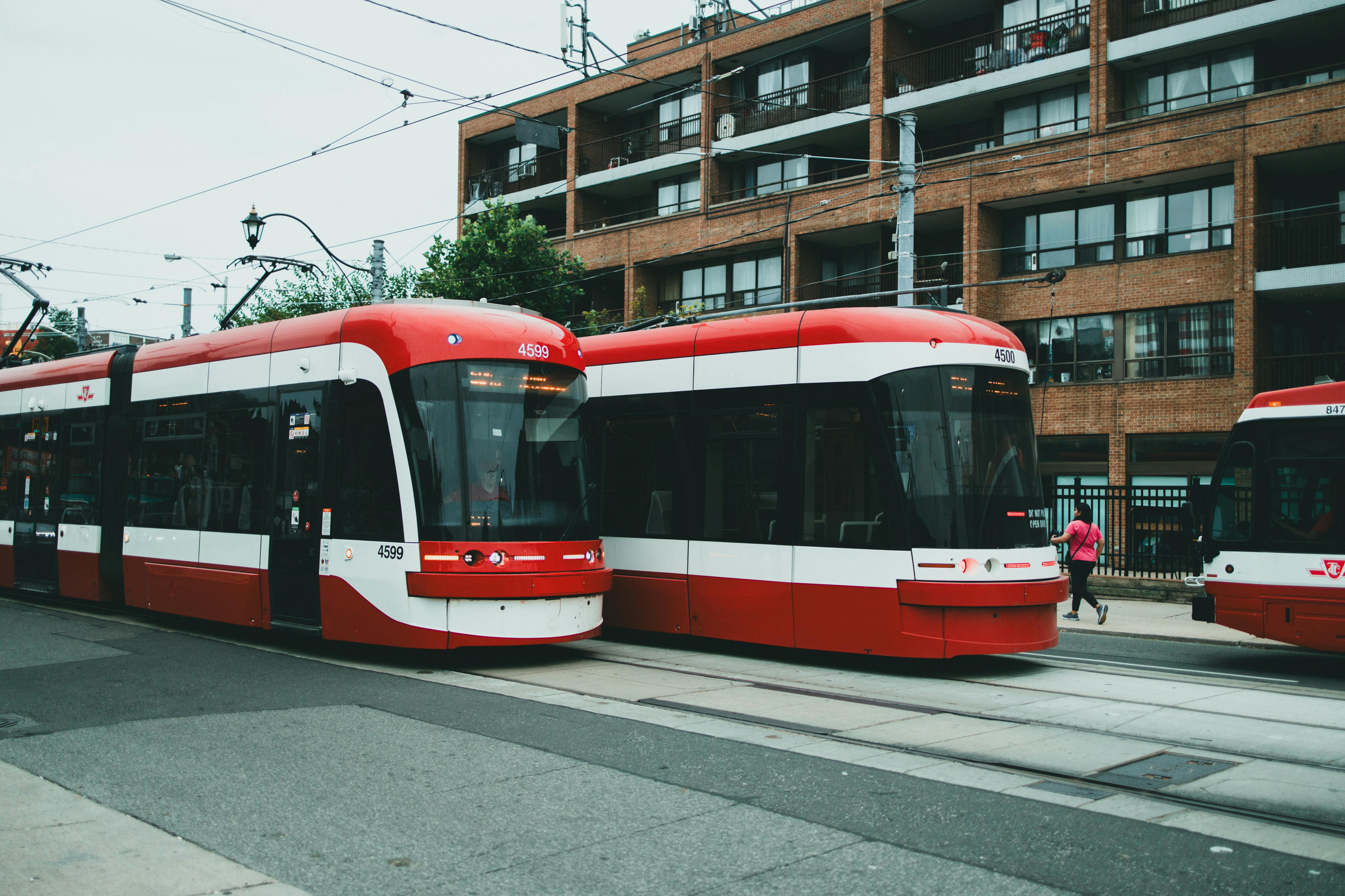 Two red and white trains on the tracks · Free Stock Photo