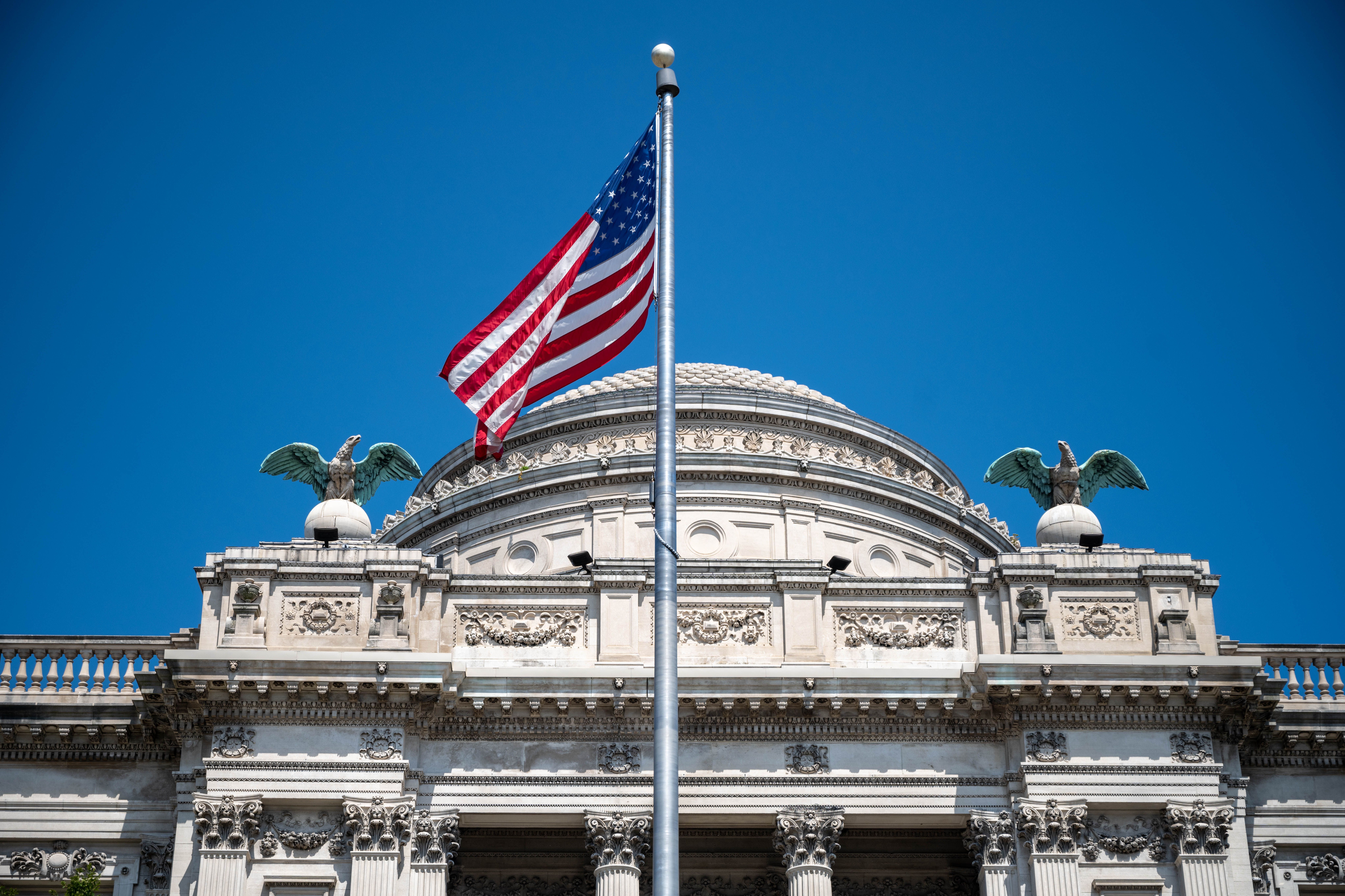The american flag flies over the capitol building · Free Stock Photo