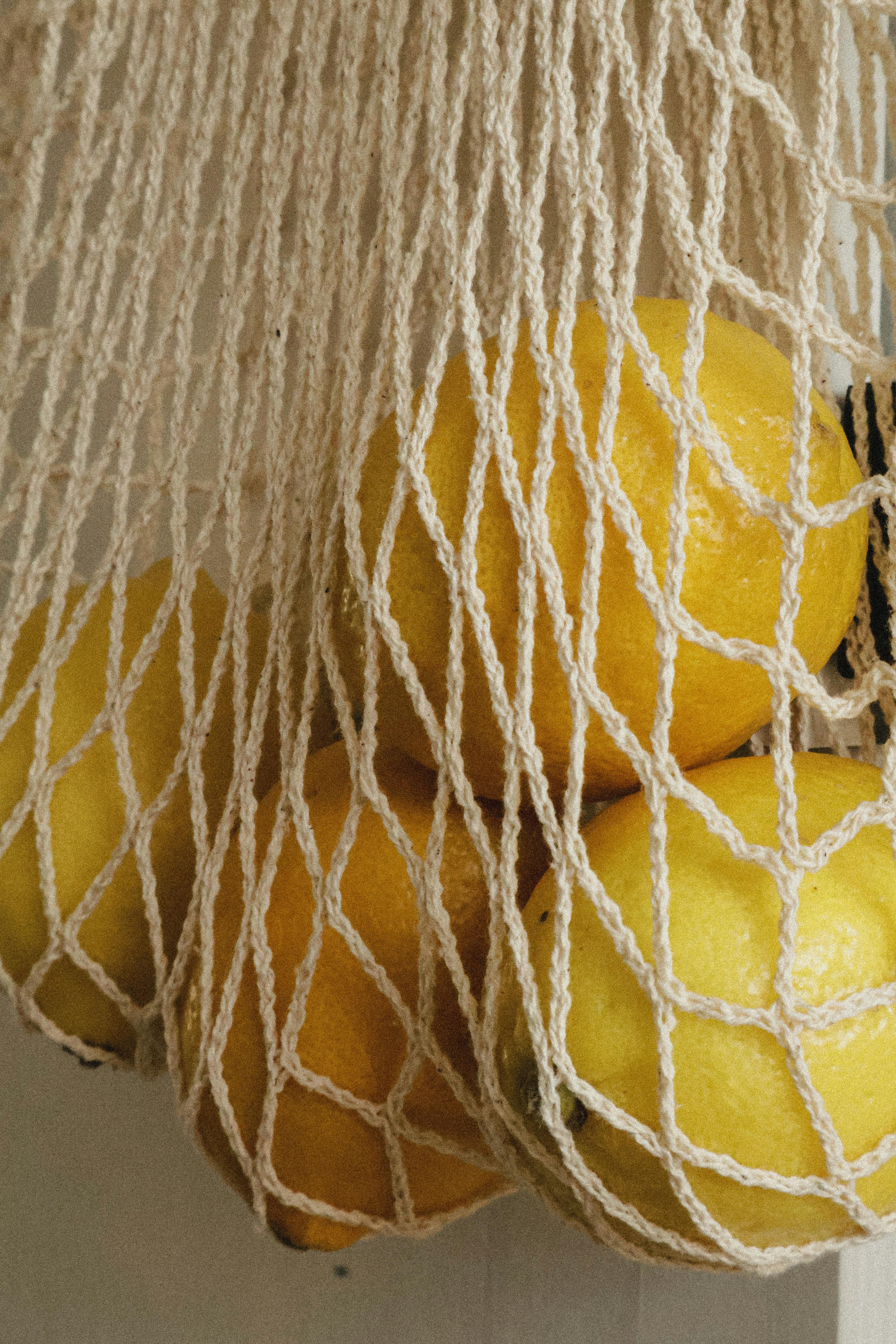 A white net bag filled with lemons · Free Stock Photo