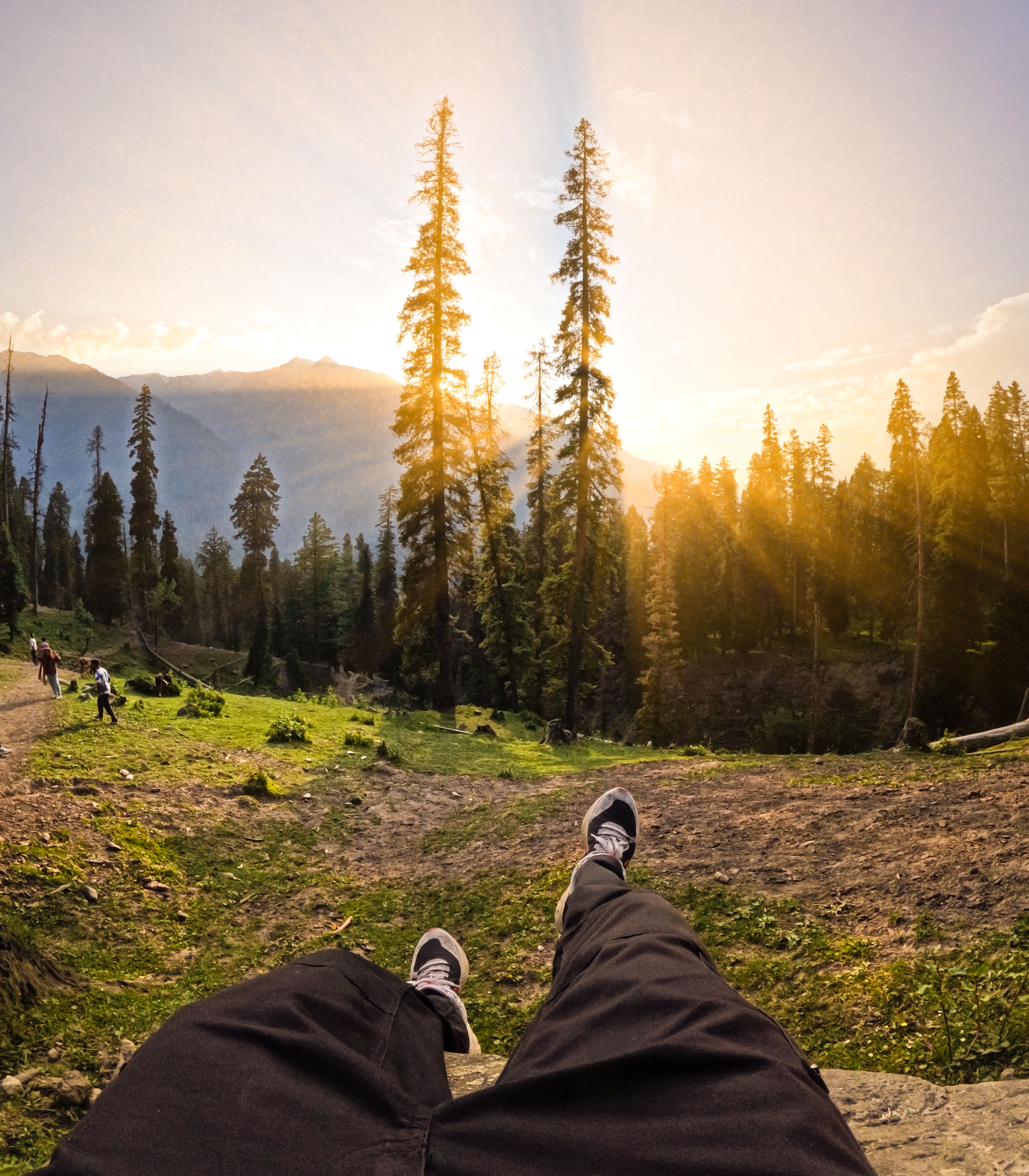 A person laying down on the ground with their feet up · Free Stock Photo