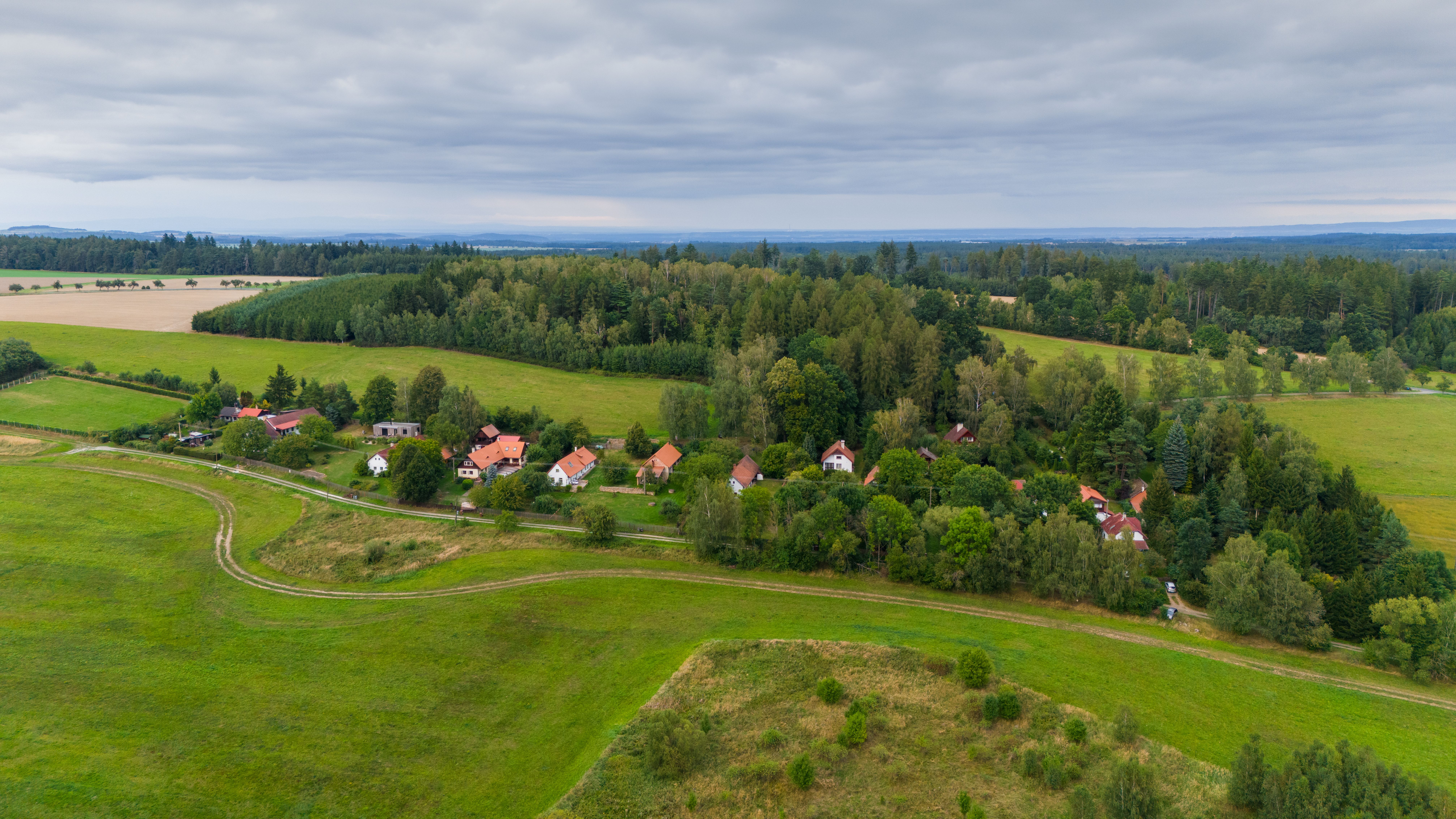 Aerial view of a rural area with a farm and trees · Free Stock Photo