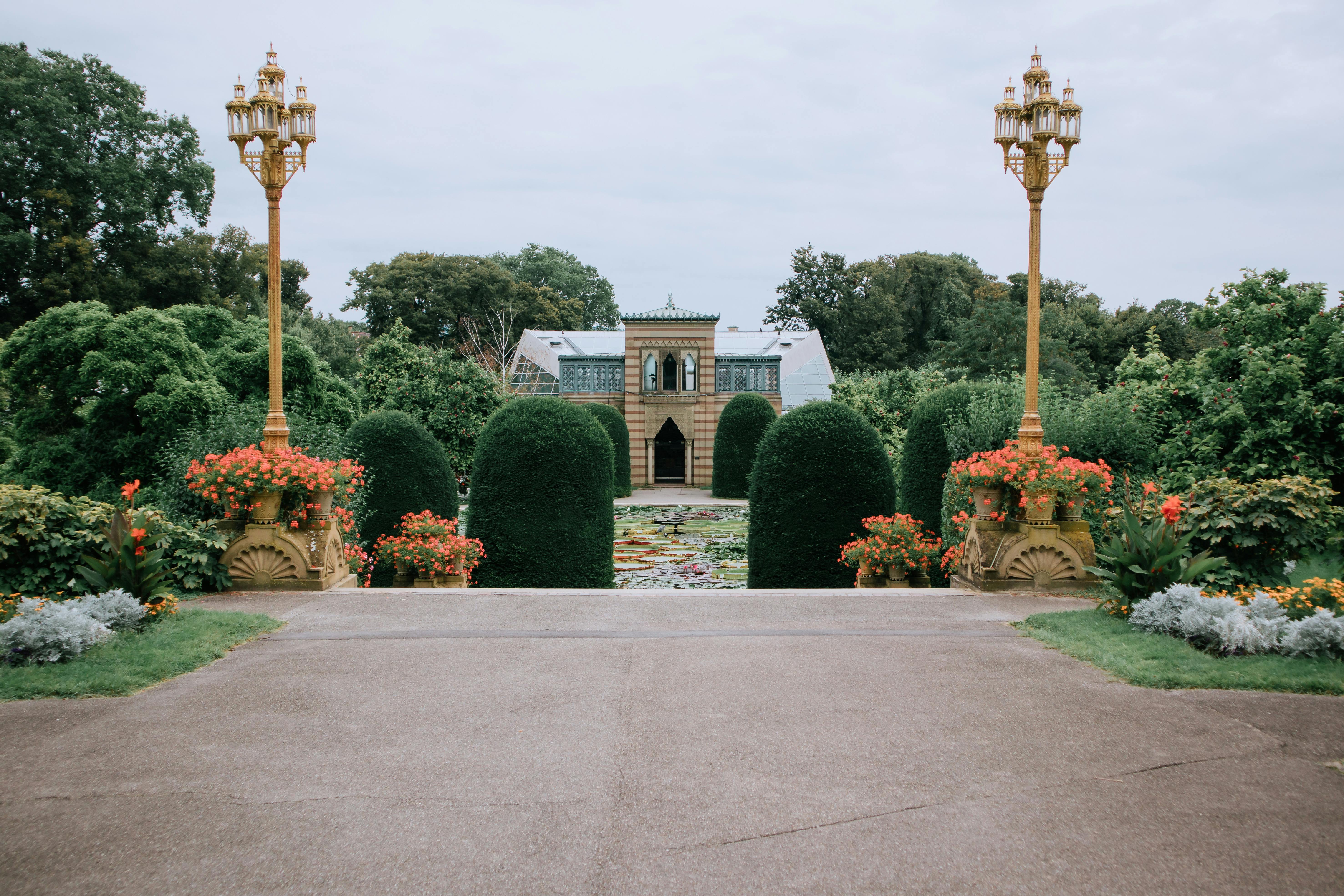 A garden with a path leading to a gate · Free Stock Photo