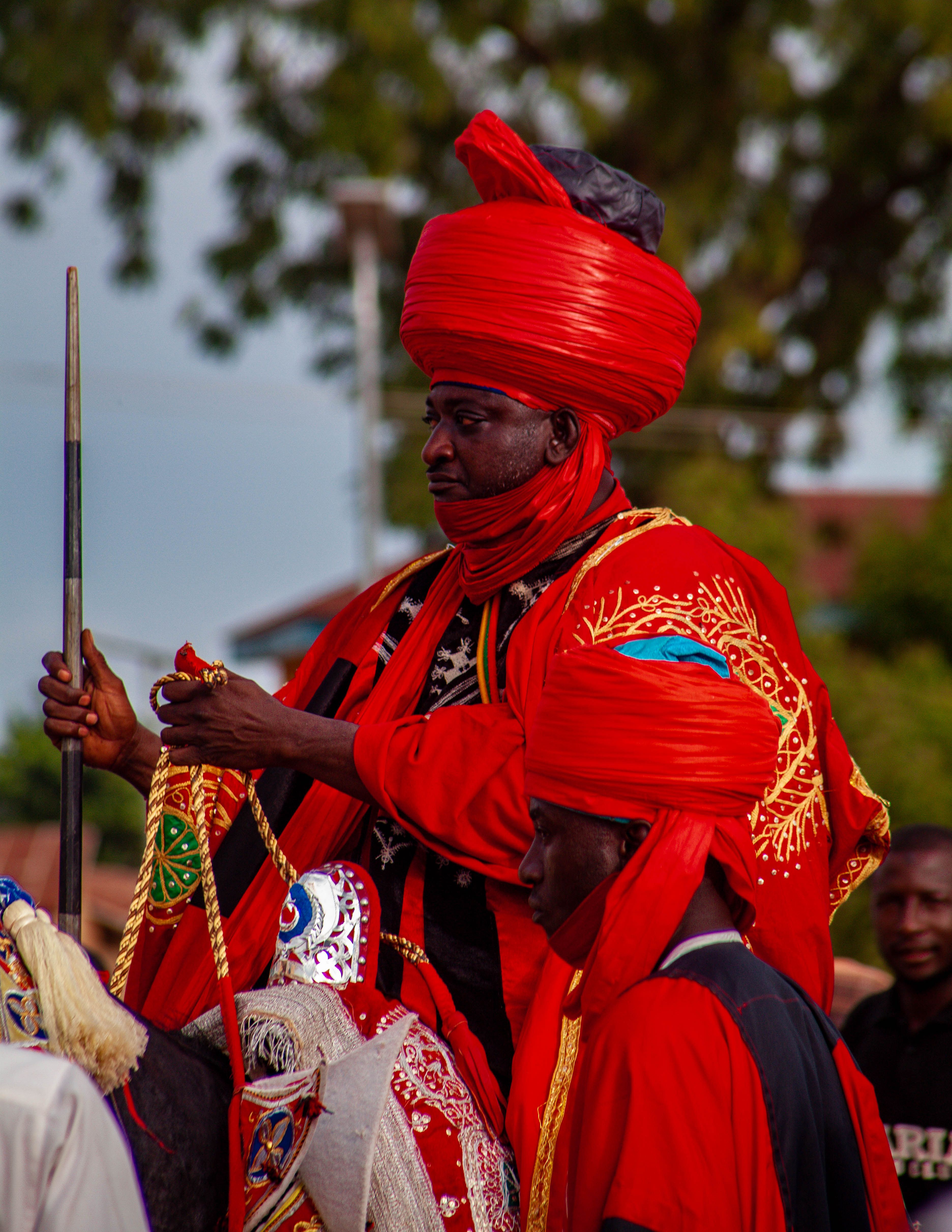 A man in red and white clothing holding a stick · Free Stock Photo