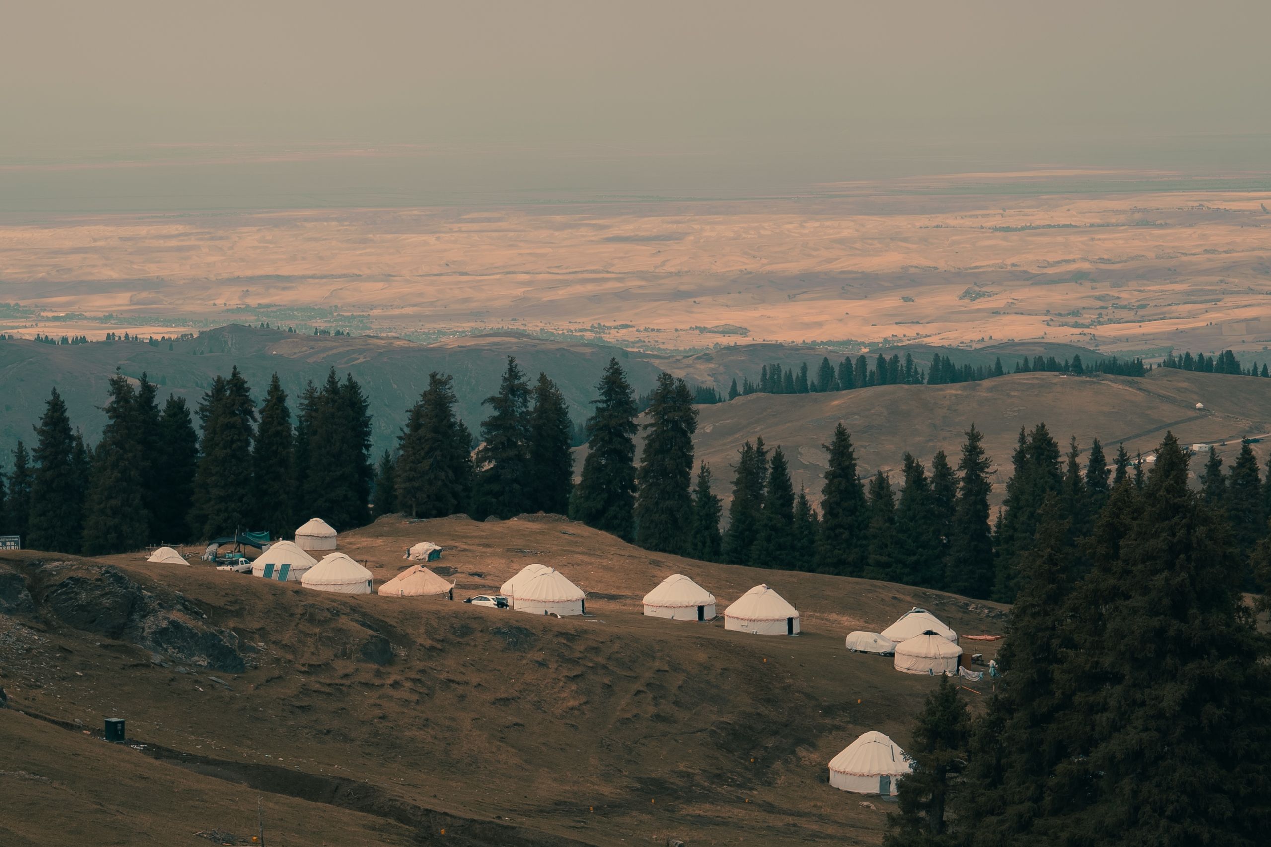 A group of yurts on top of a hill · Free Stock Photo