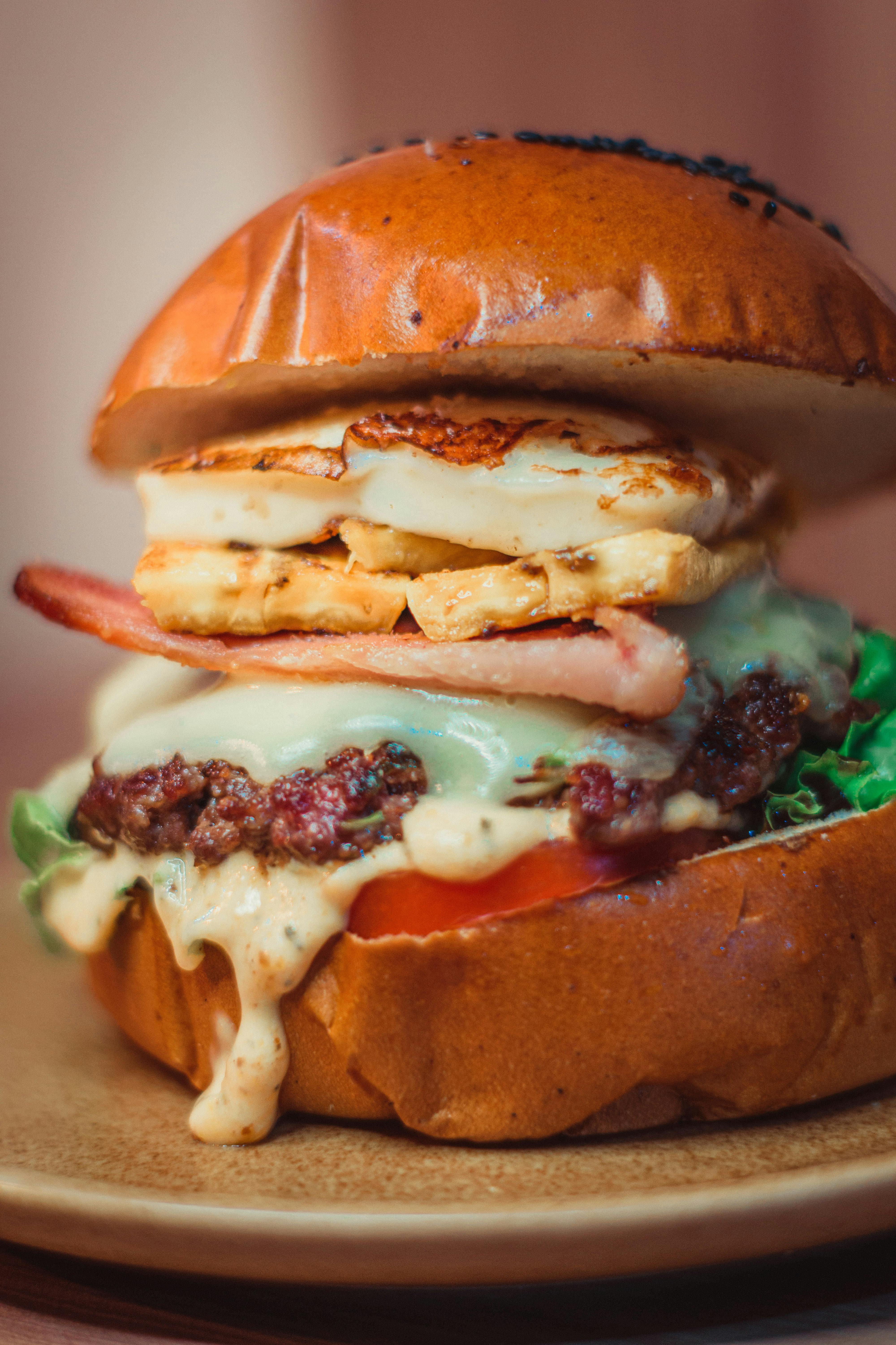 Loaded Burger on Wooden Plate · Free Stock Photo
