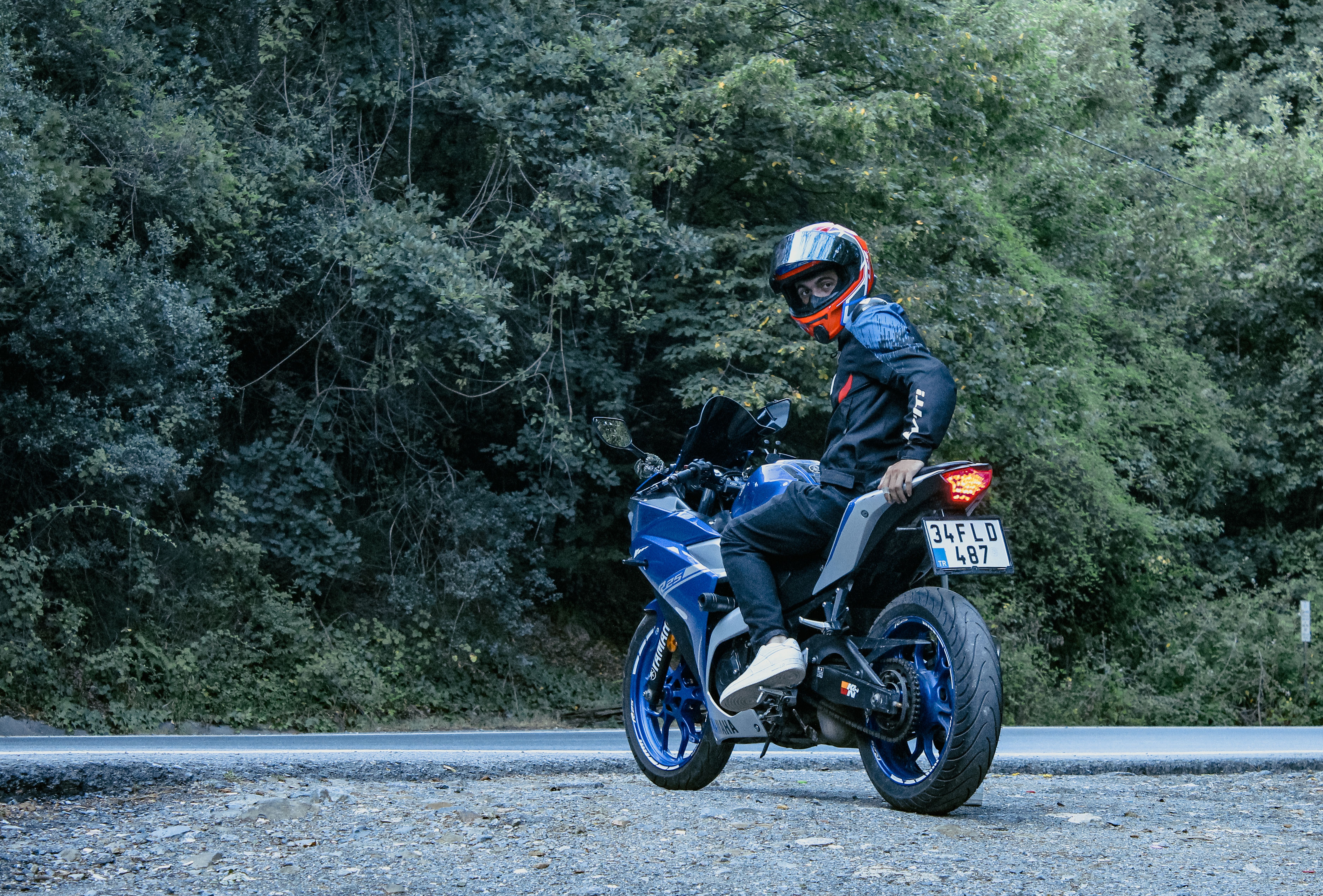 A person riding a motorcycle on a road · Free Stock Photo