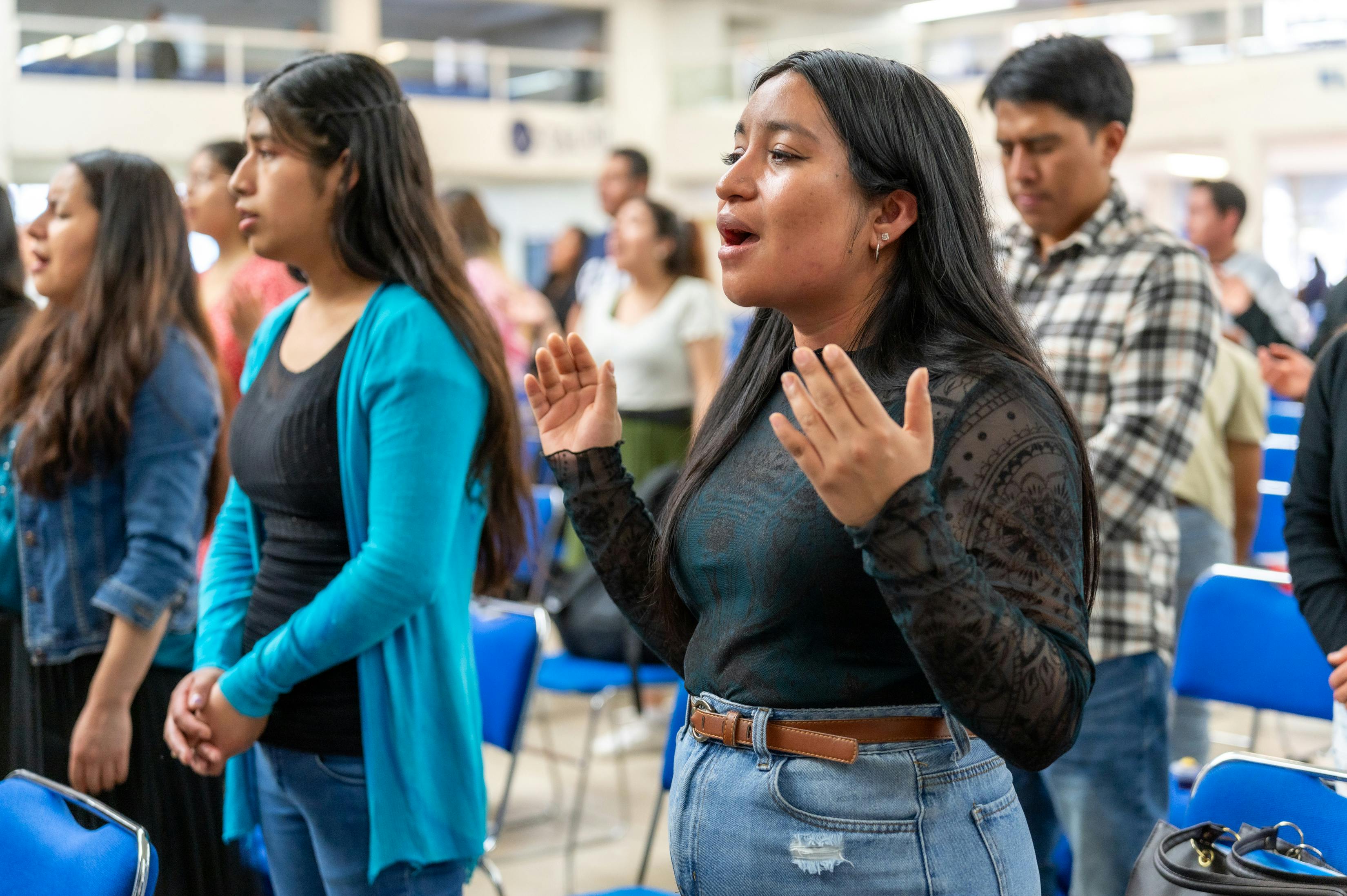 A group of people are singing in a church · Free Stock Photo