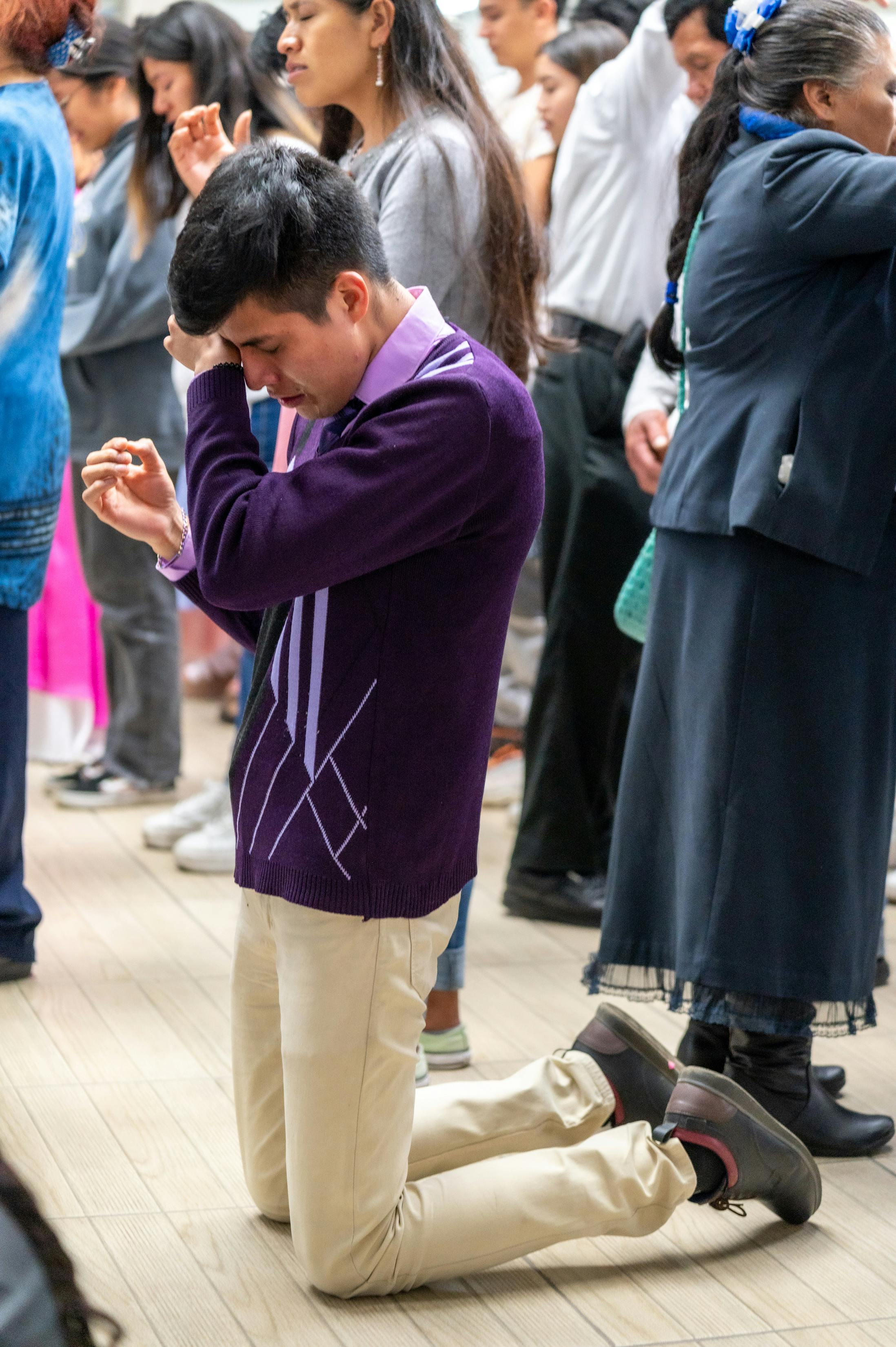 A man kneeling down in a crowd of people · Free Stock Photo