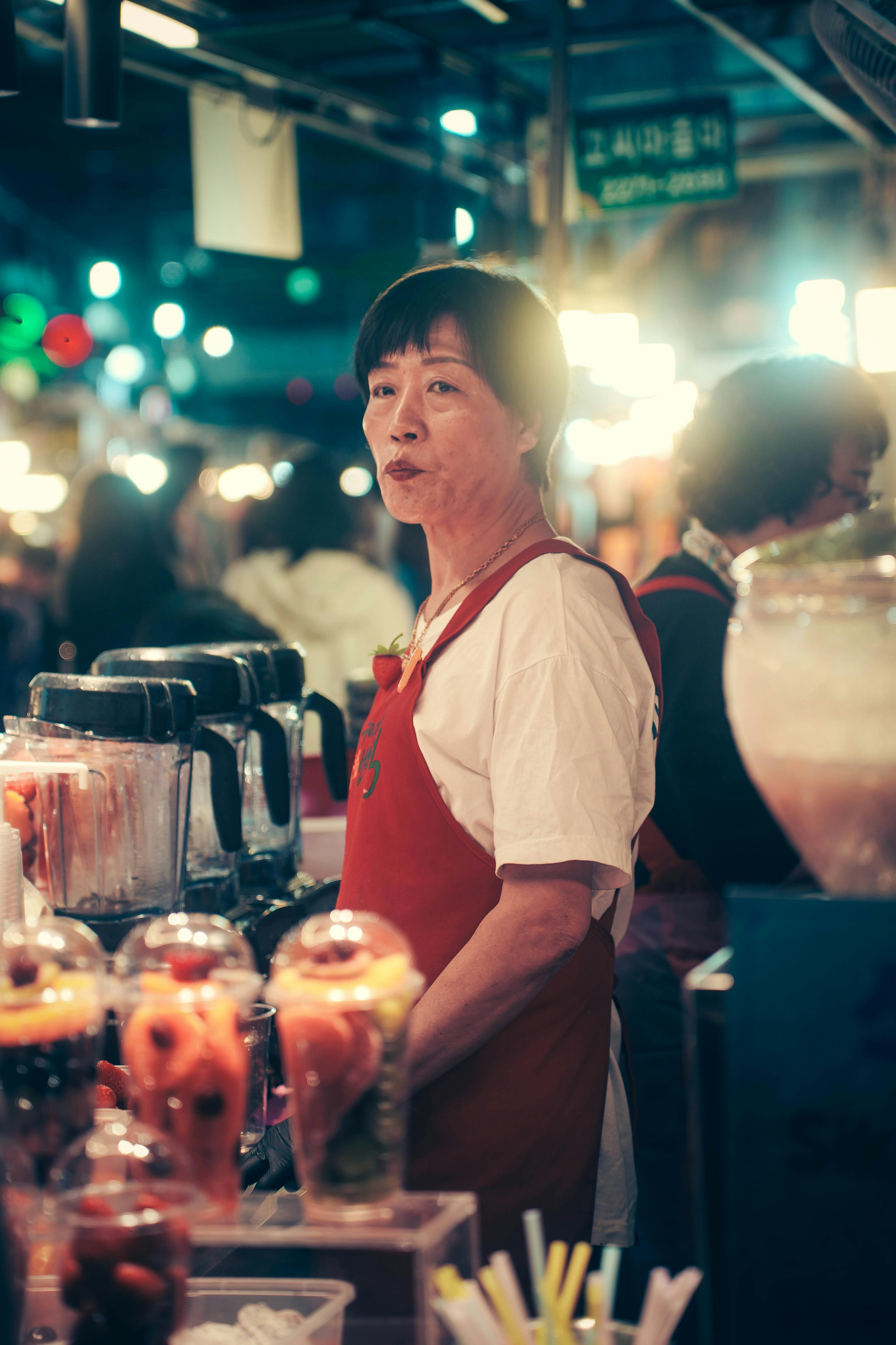 Person in Black Shirt Standing in Front of Store · Free Stock Photo