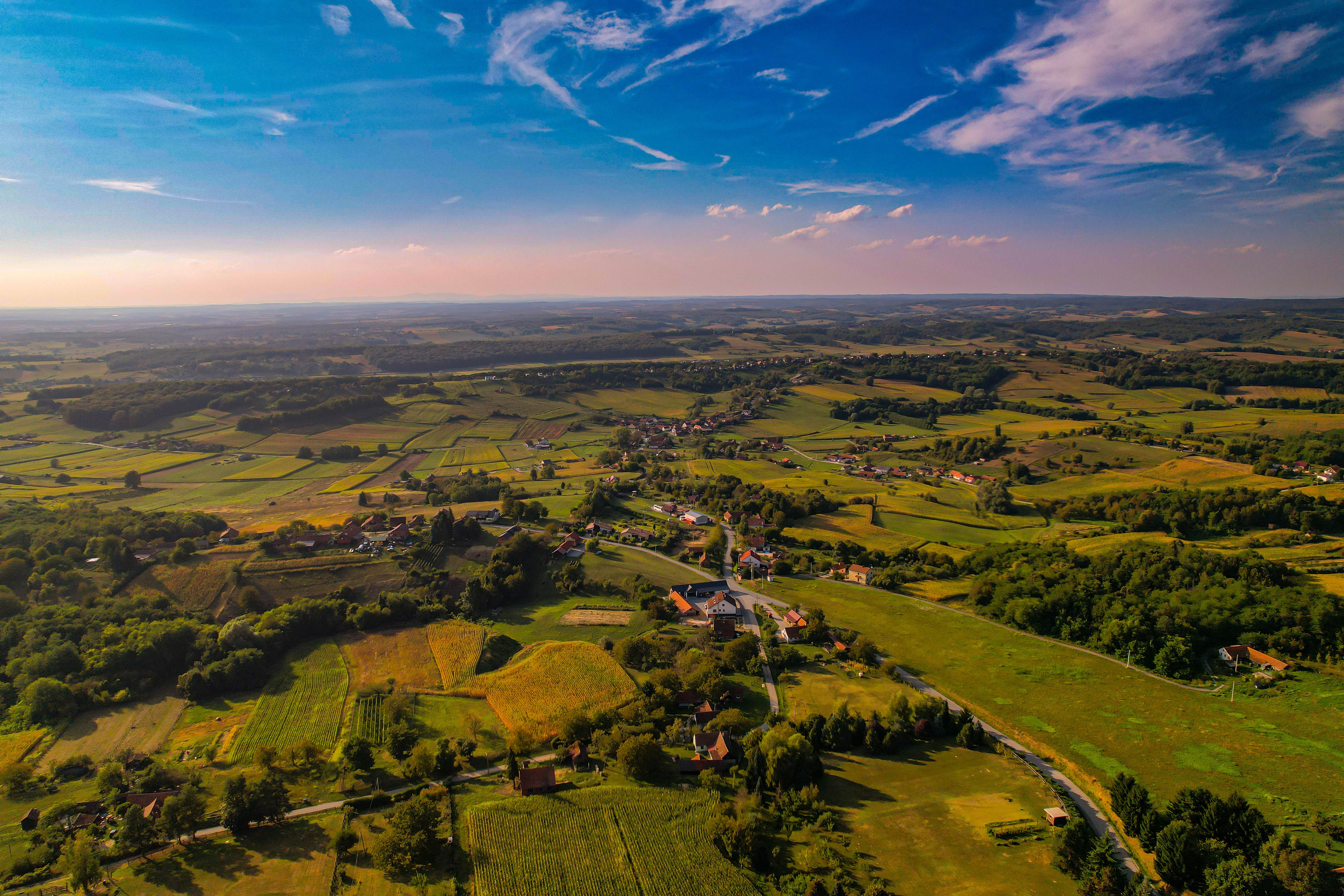 Aerial view of a rural landscape with fields and trees · Free Stock Photo