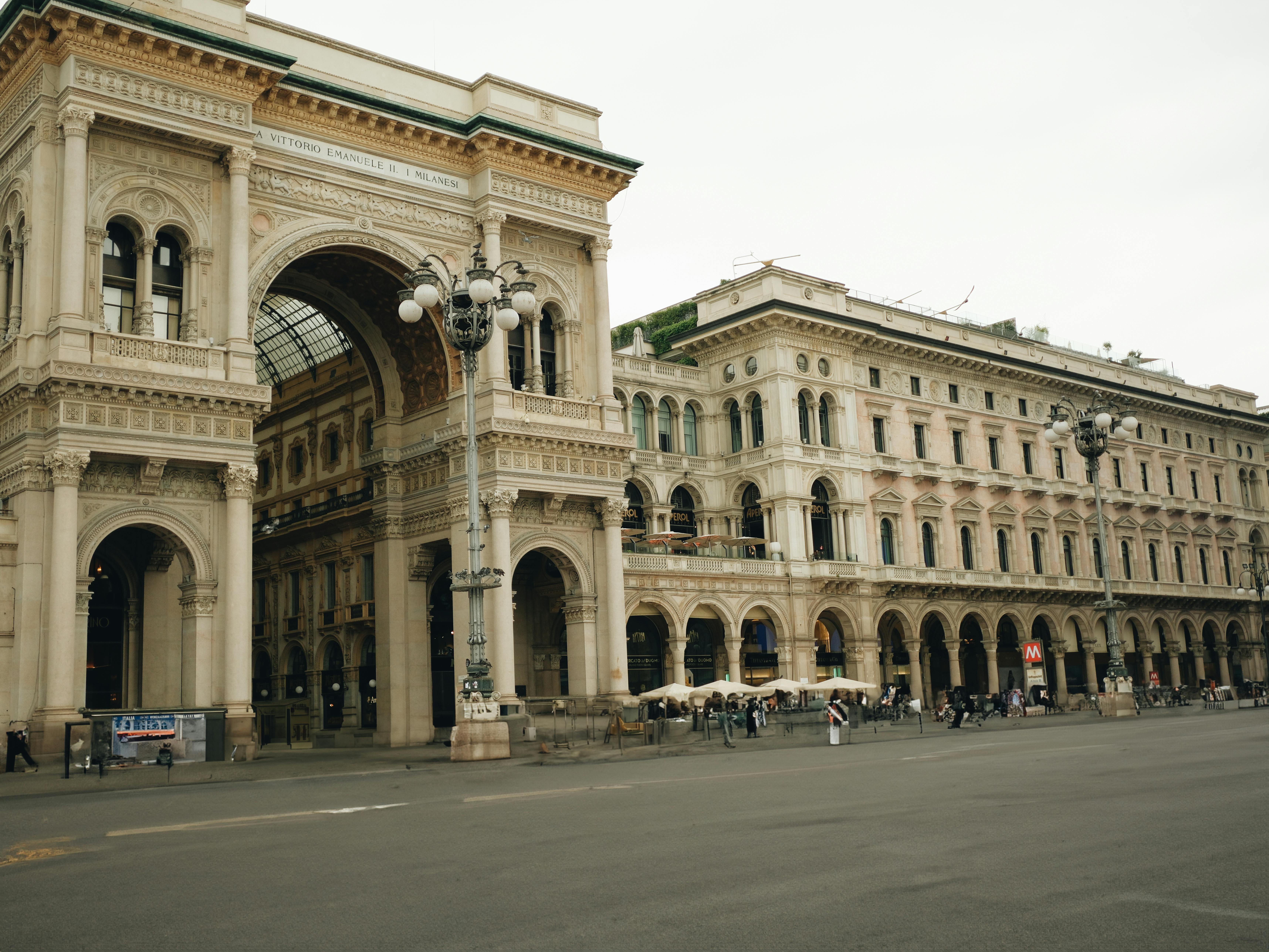 A large building with arches and a clock tower · Free Stock Photo