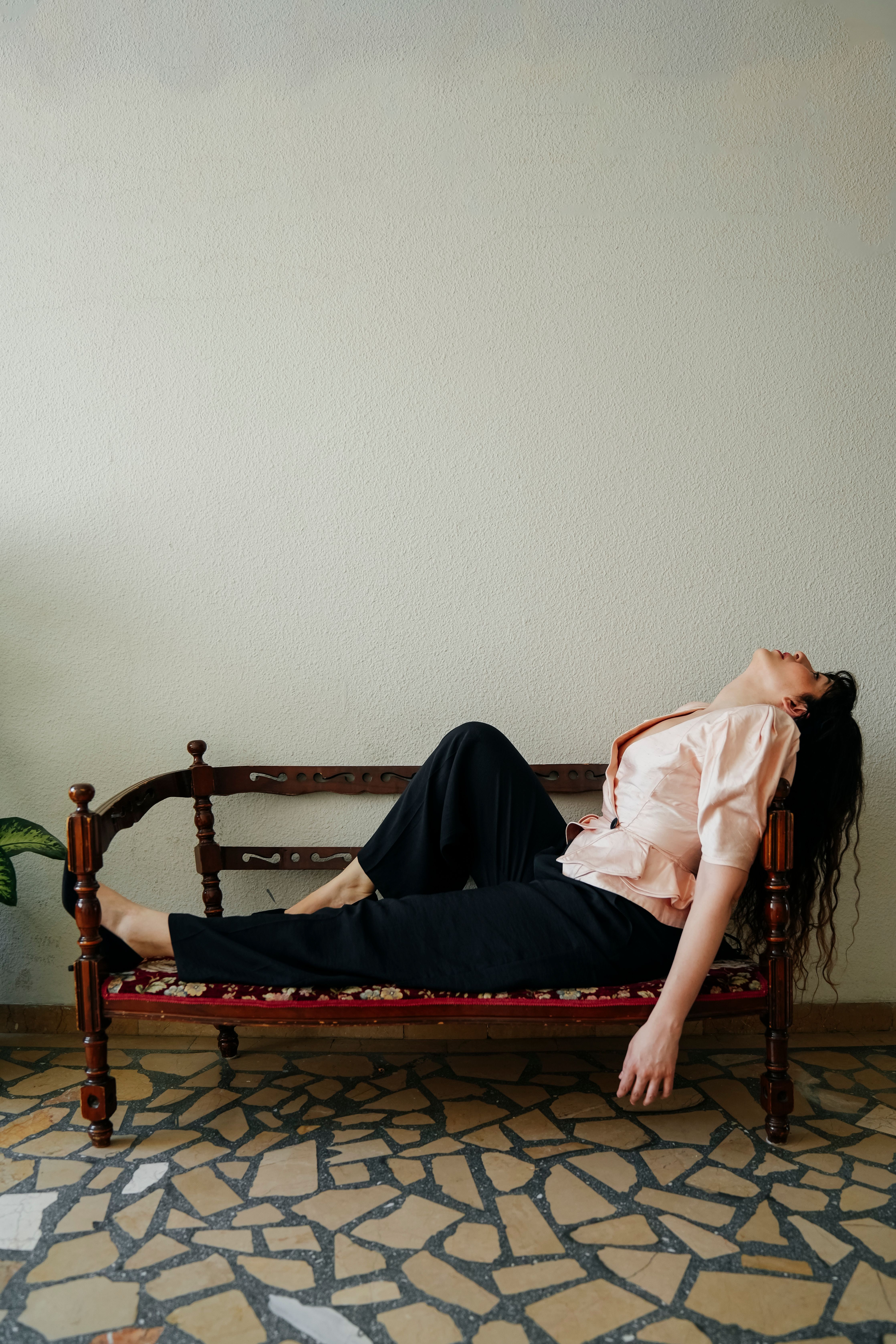 A woman laying on a bench in a room · Free Stock Photo