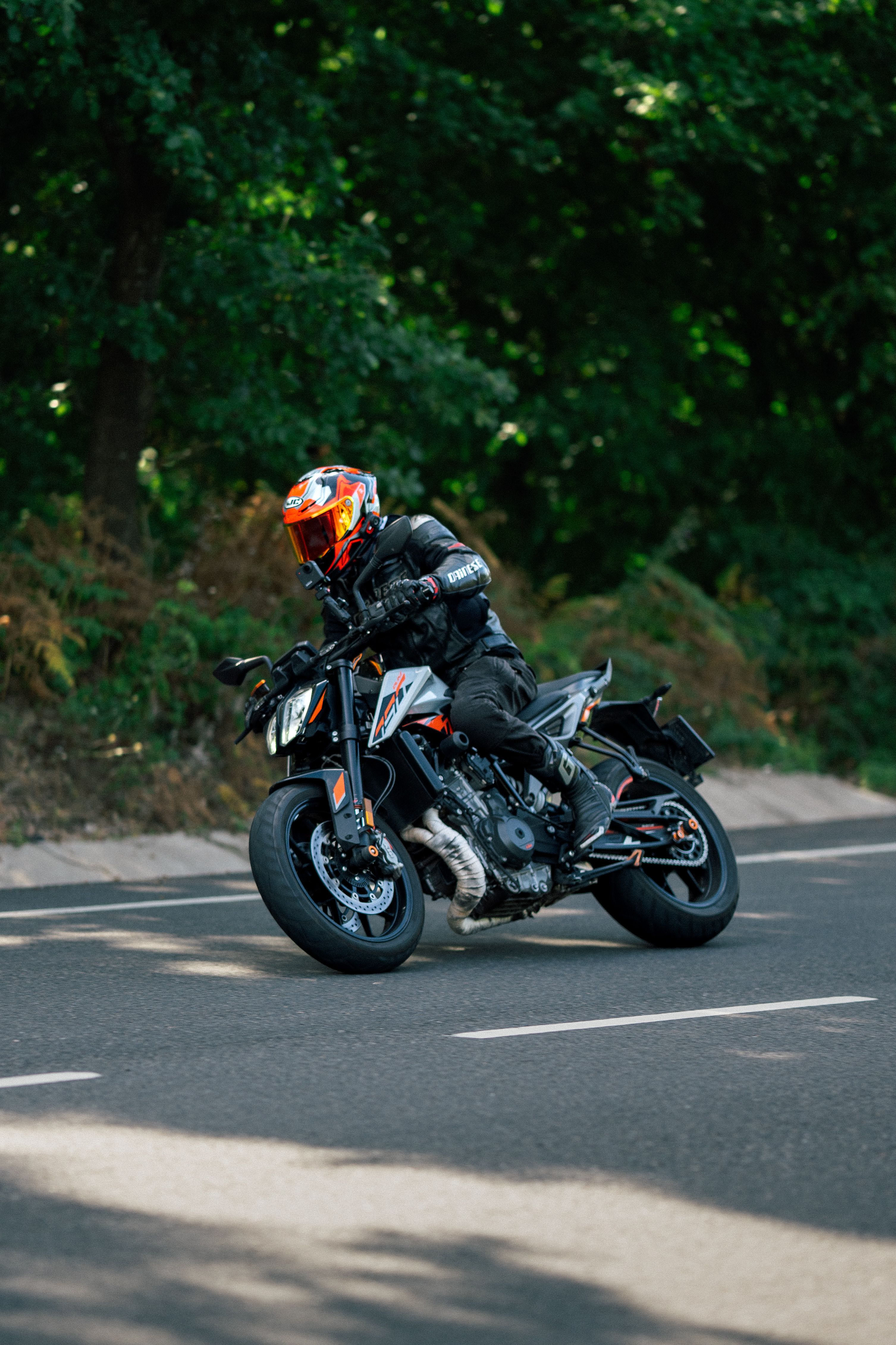 A person riding a motorcycle on a road · Free Stock Photo