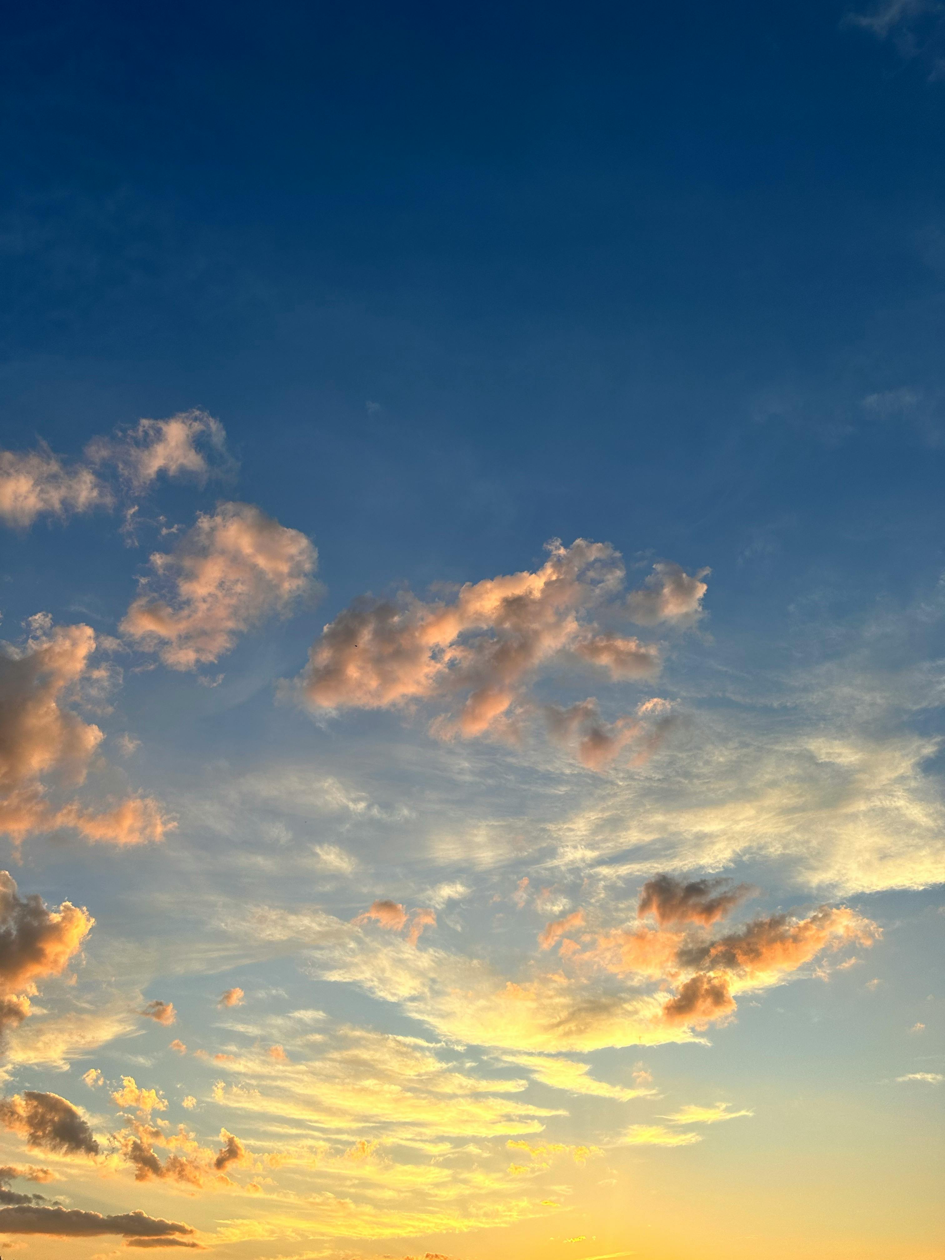 A sunset with clouds and a blue sky · Free Stock Photo